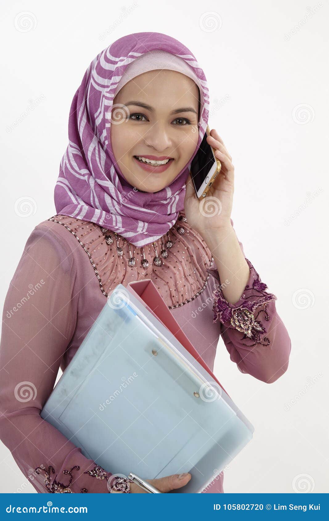 Woman tusing smart phone stock photo. Image of kurung - 105802720