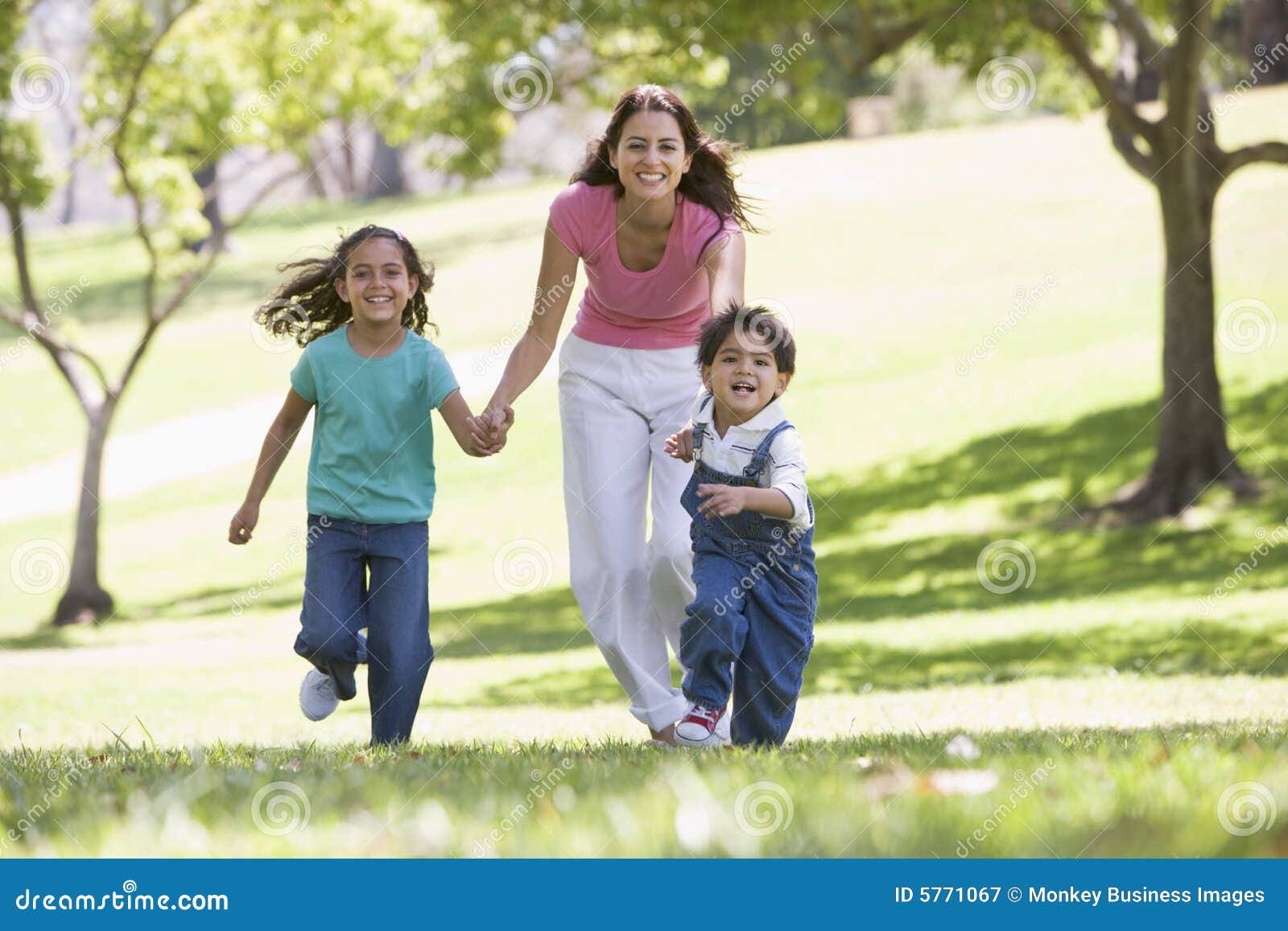 Woman with Two Young Children Running Smiling Stock Image - Image of ...