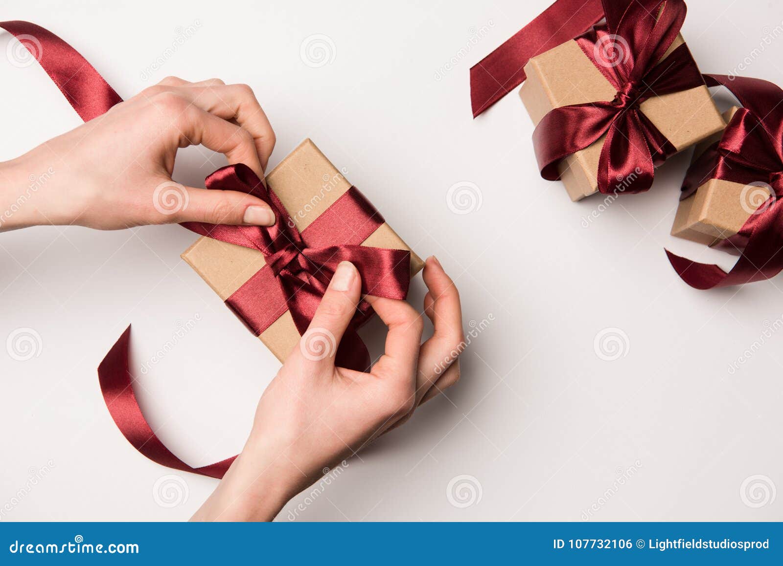 Woman Tying Ribbon on Gift Box Isolated on White Stock Photo - Image of ...