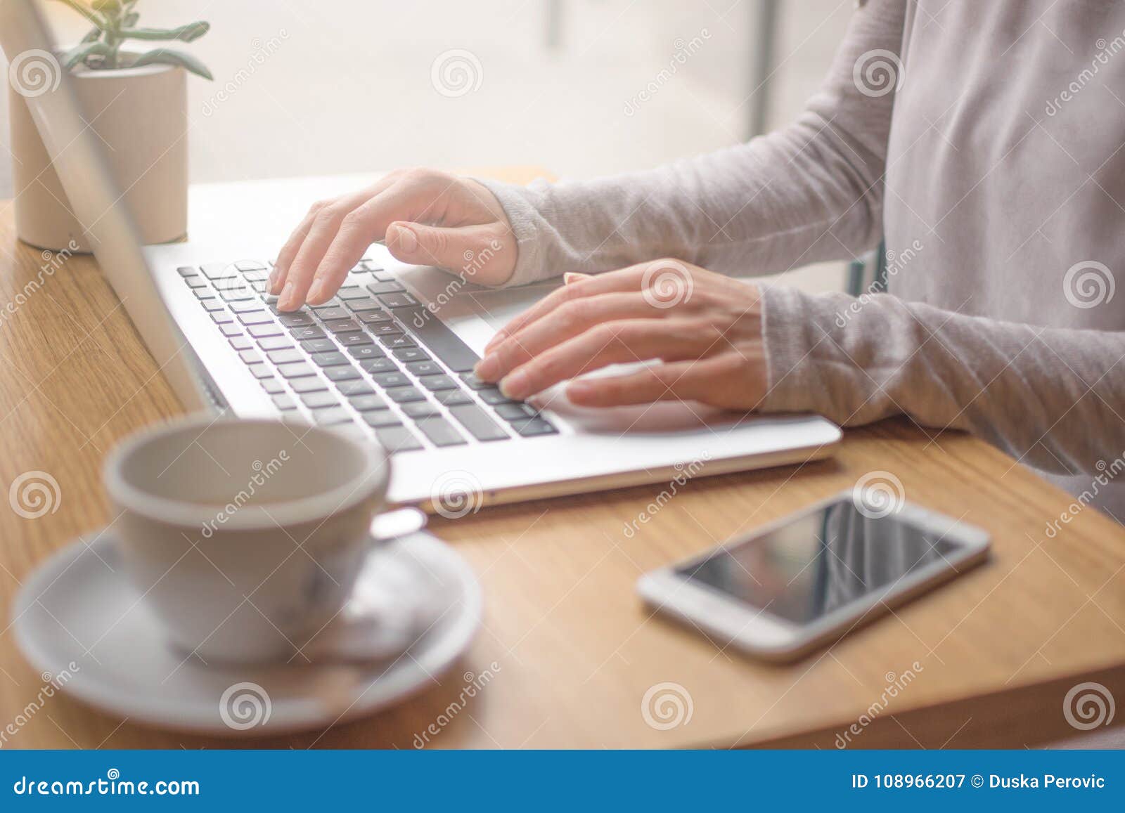 Woman Typing on Laptop Computer and Using Smart Phone Stock Image ...