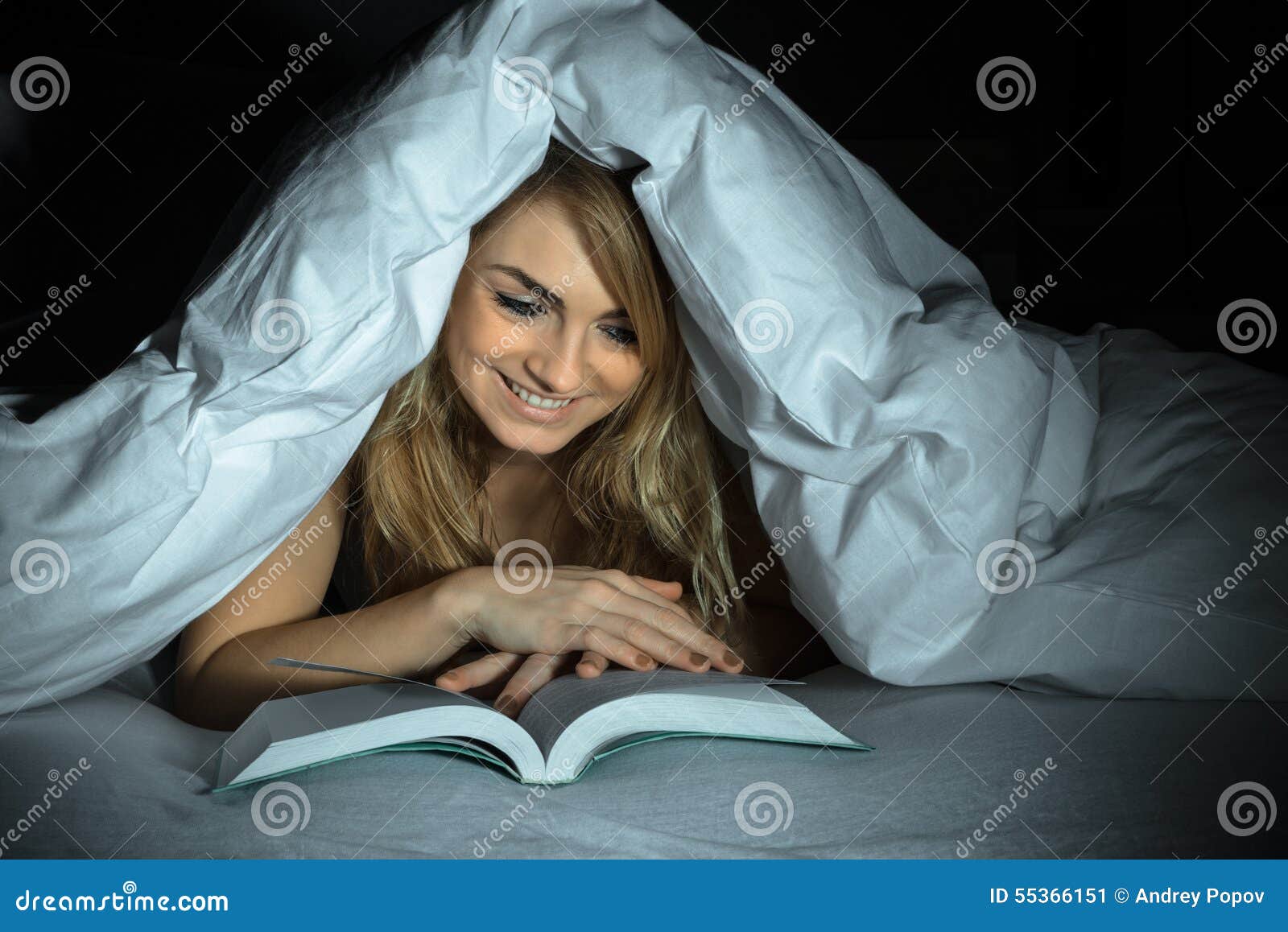 Woman Under Bedding Reading Book Stock Image - Image of happiness ...