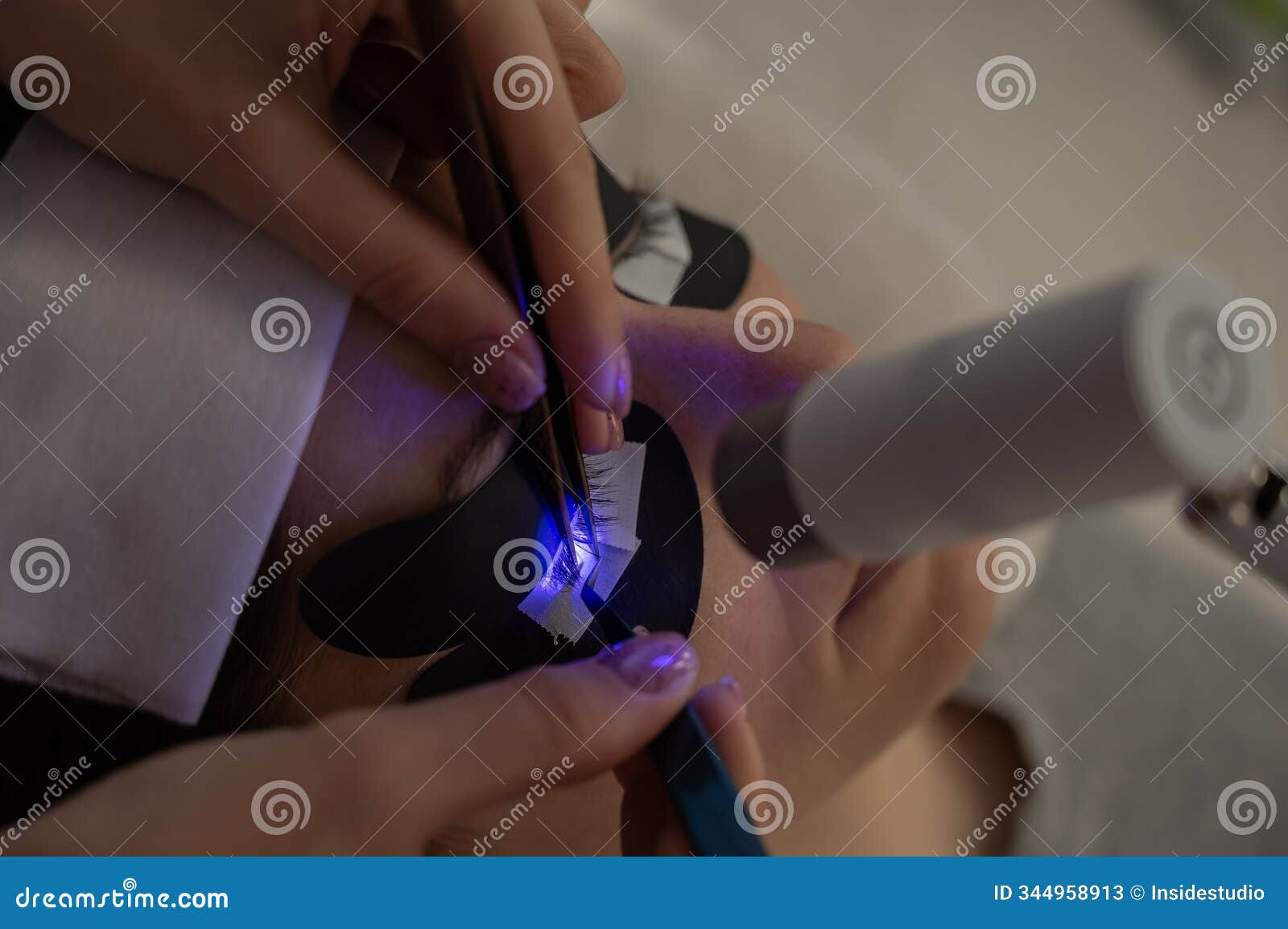 A Woman Undergoing Eyelash Extension Procedure Using an Ultraviolet ...