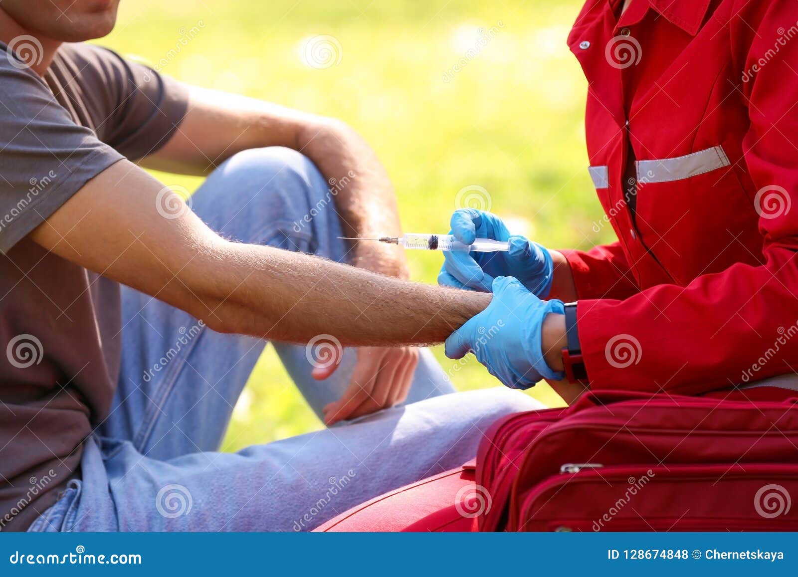 Woman in Uniform Doing Injection To Man Outdoors Stock Photo - Image of ...