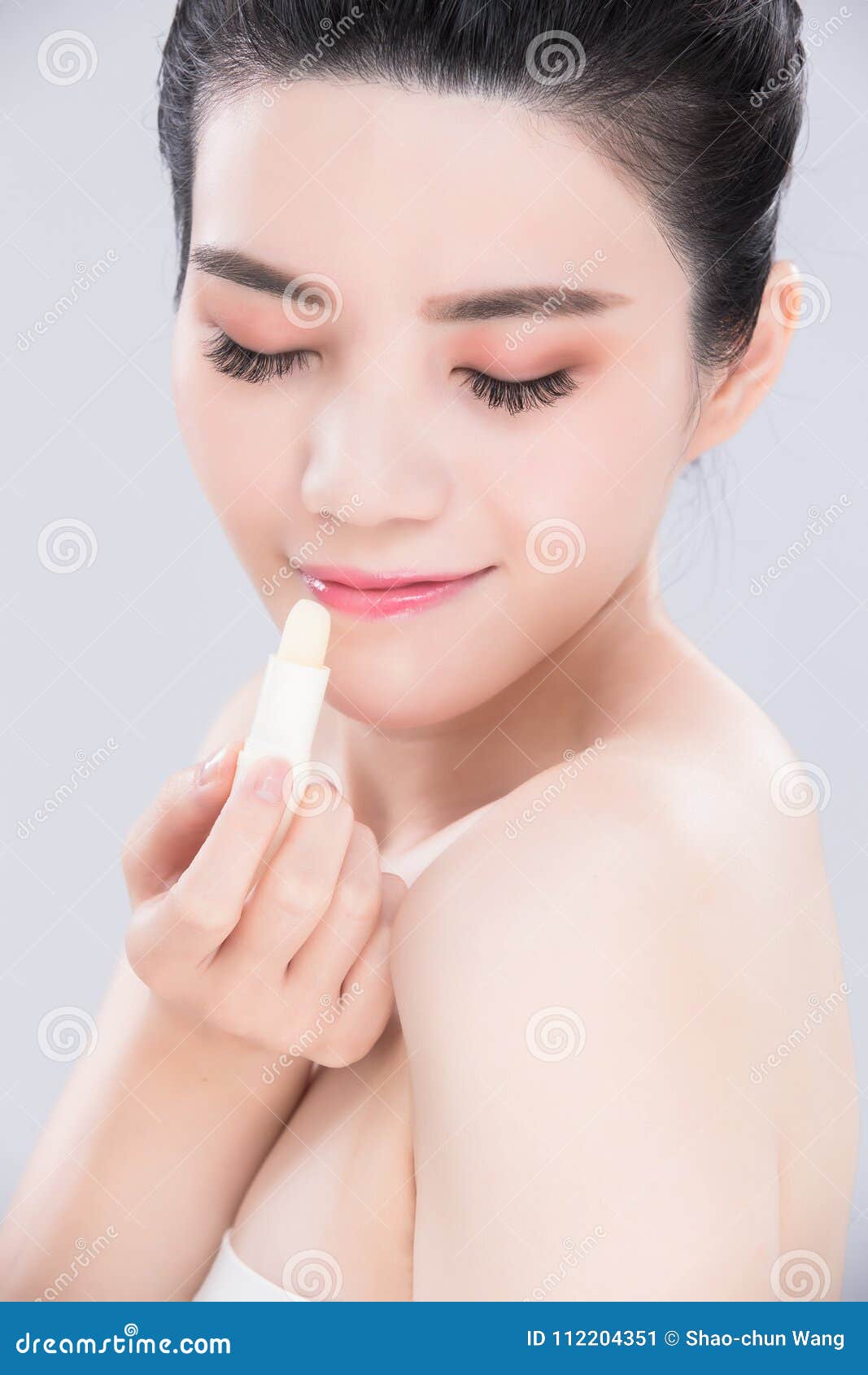 Woman use lip balm stock image. Image of face, attractive - 112204351