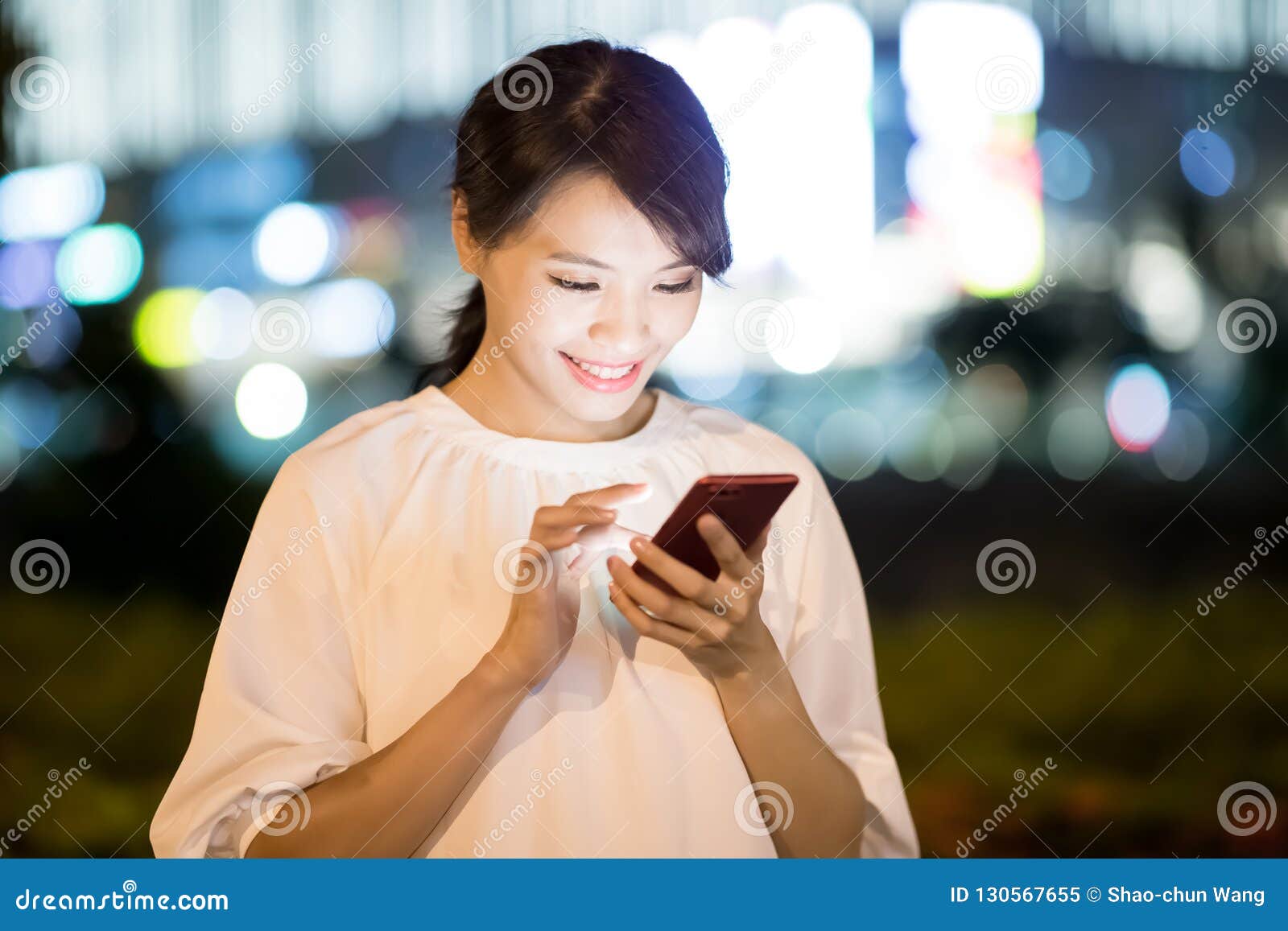 Woman use phone happily stock image. Image of network - 130567655