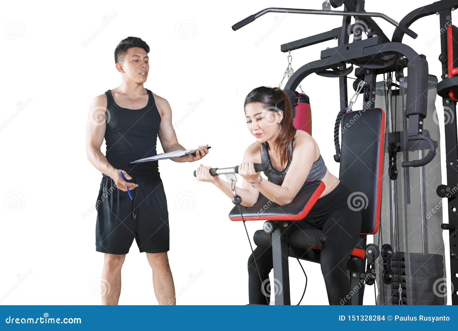 Woman Uses Exercise Machine with Her Trainer Stock Photo - Image of ...