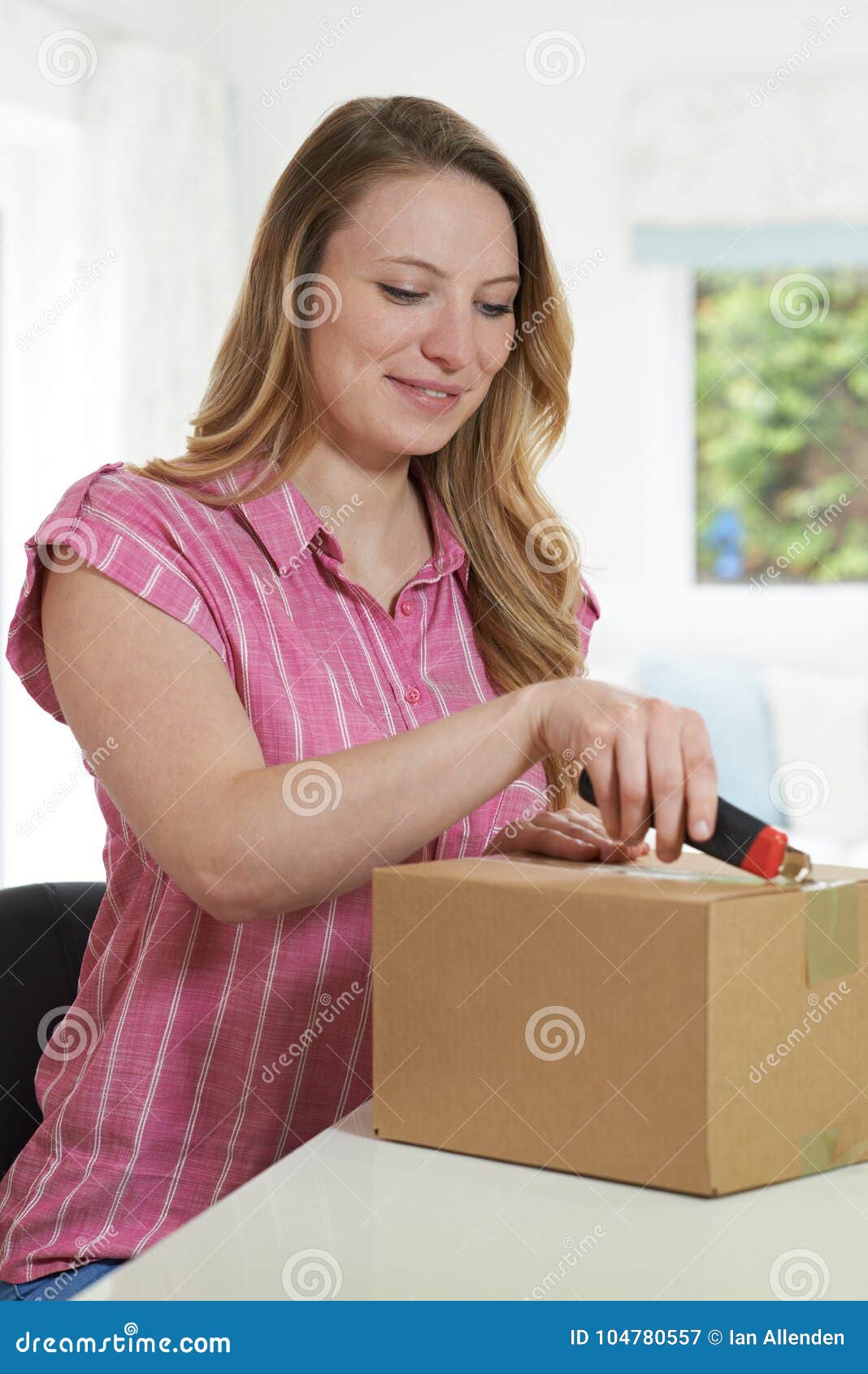 Woman Using Knife To Open Package at Home Stock Image - Image of ...