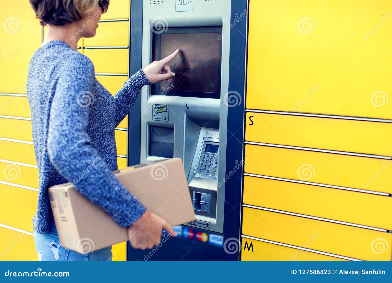 Woman Using Automated Self Service Post Terminal Machine or Lock ...