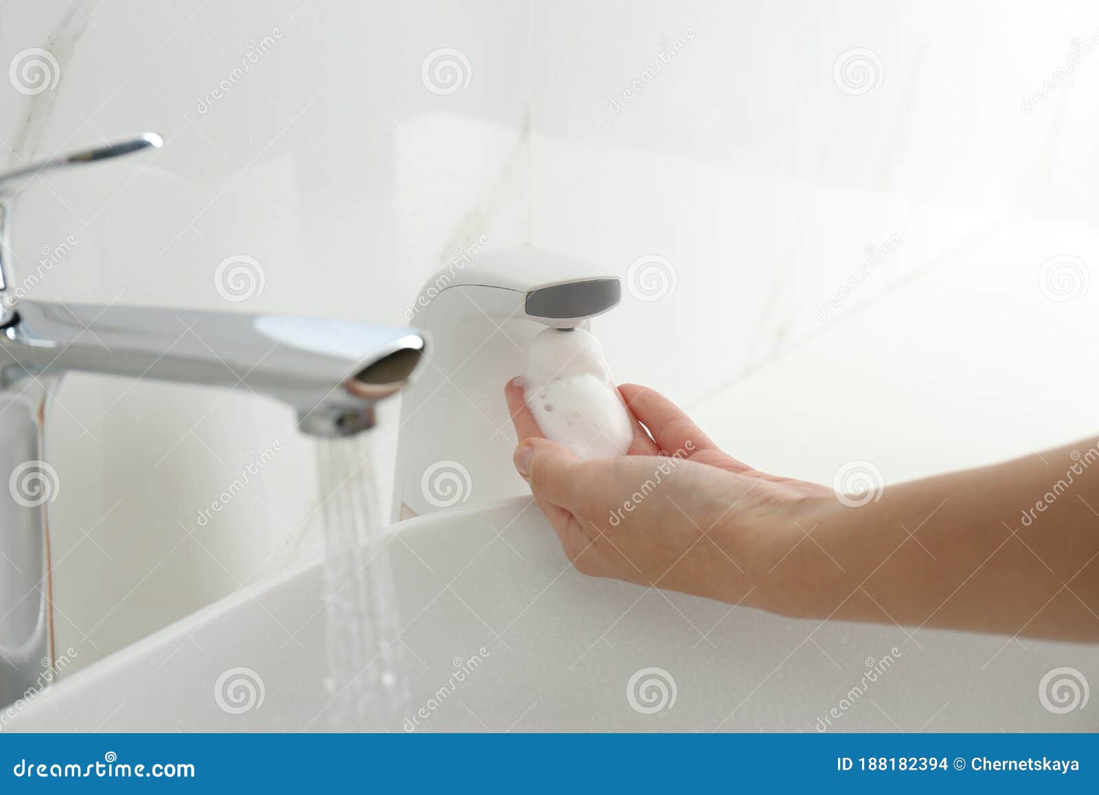 Woman Using Automatic Soap Dispenser in Bathroom Stock Photo - Image of ...