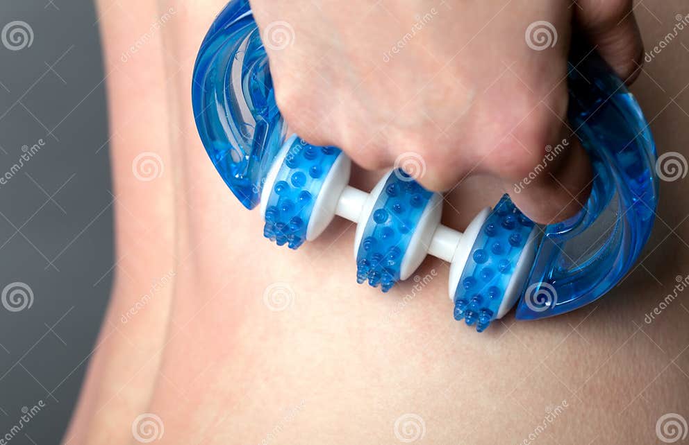 Woman using back massager stock photo. Image of holding - 23052944