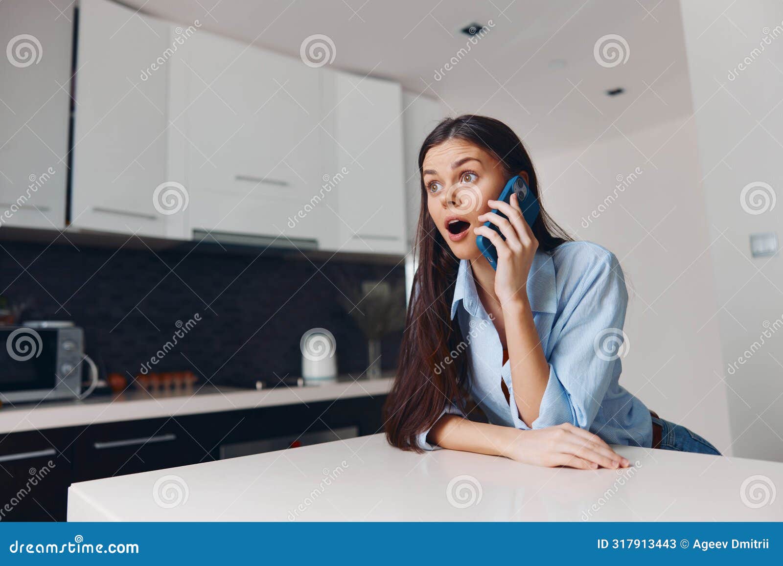 Woman Using Cell Phone at Kitchen Table, Casual Conversation in Modern ...