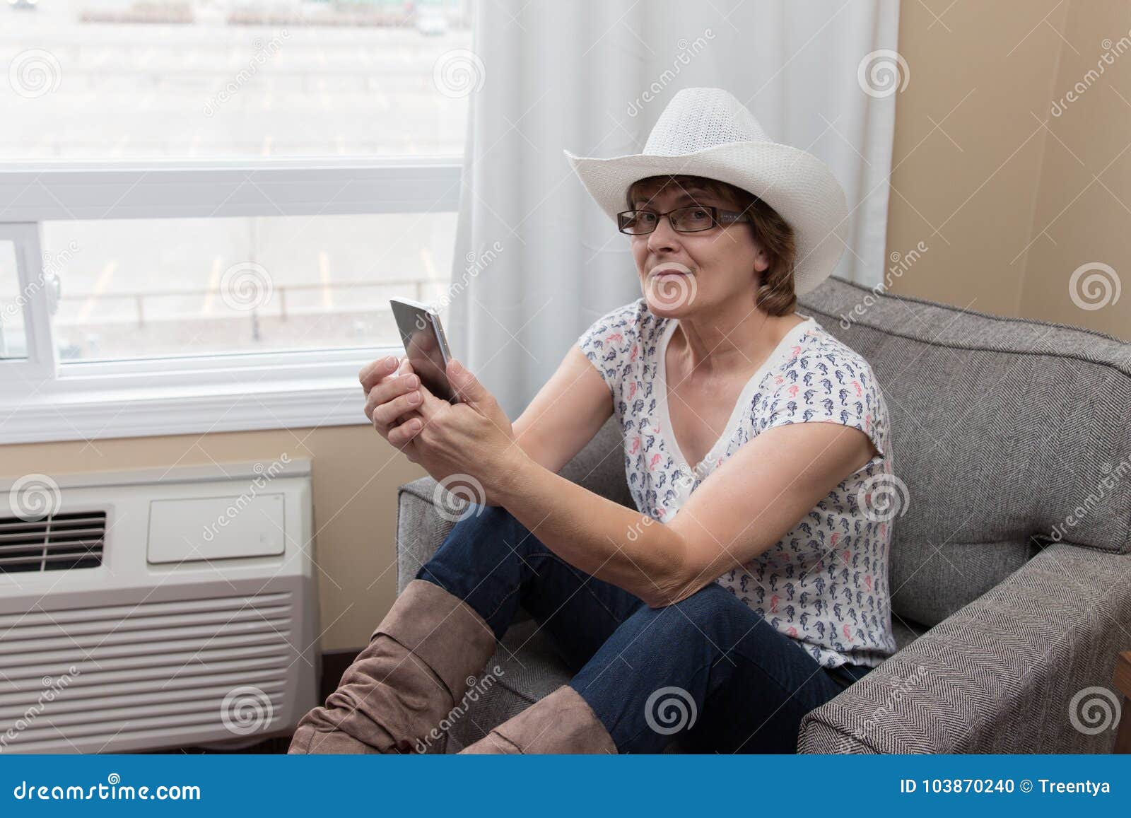 Woman Using a Cell Phone Wearing a Cowboy Hat Stock Photo - Image of ...
