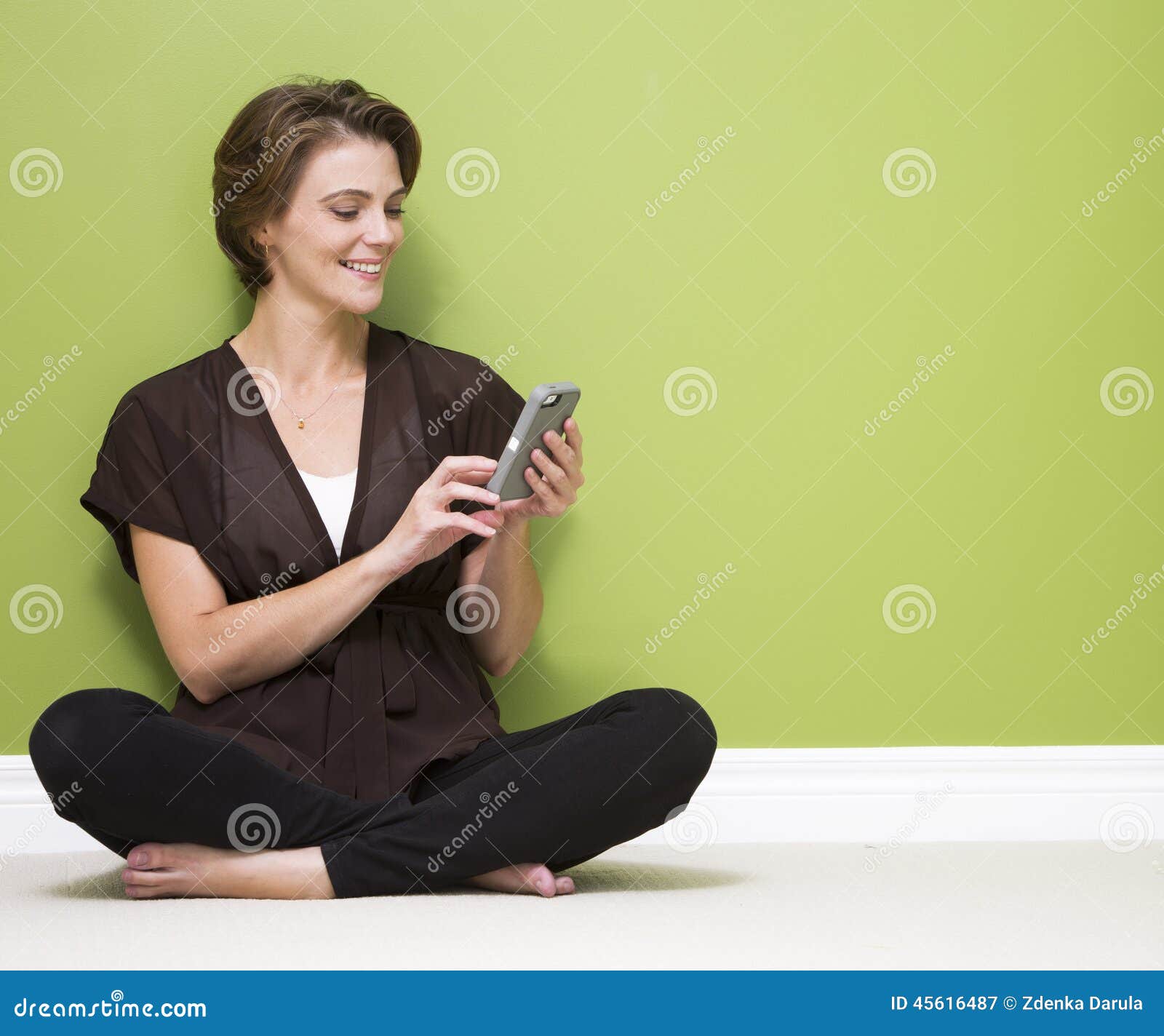 Woman using cellphone stock image. Image of room, long - 45616487