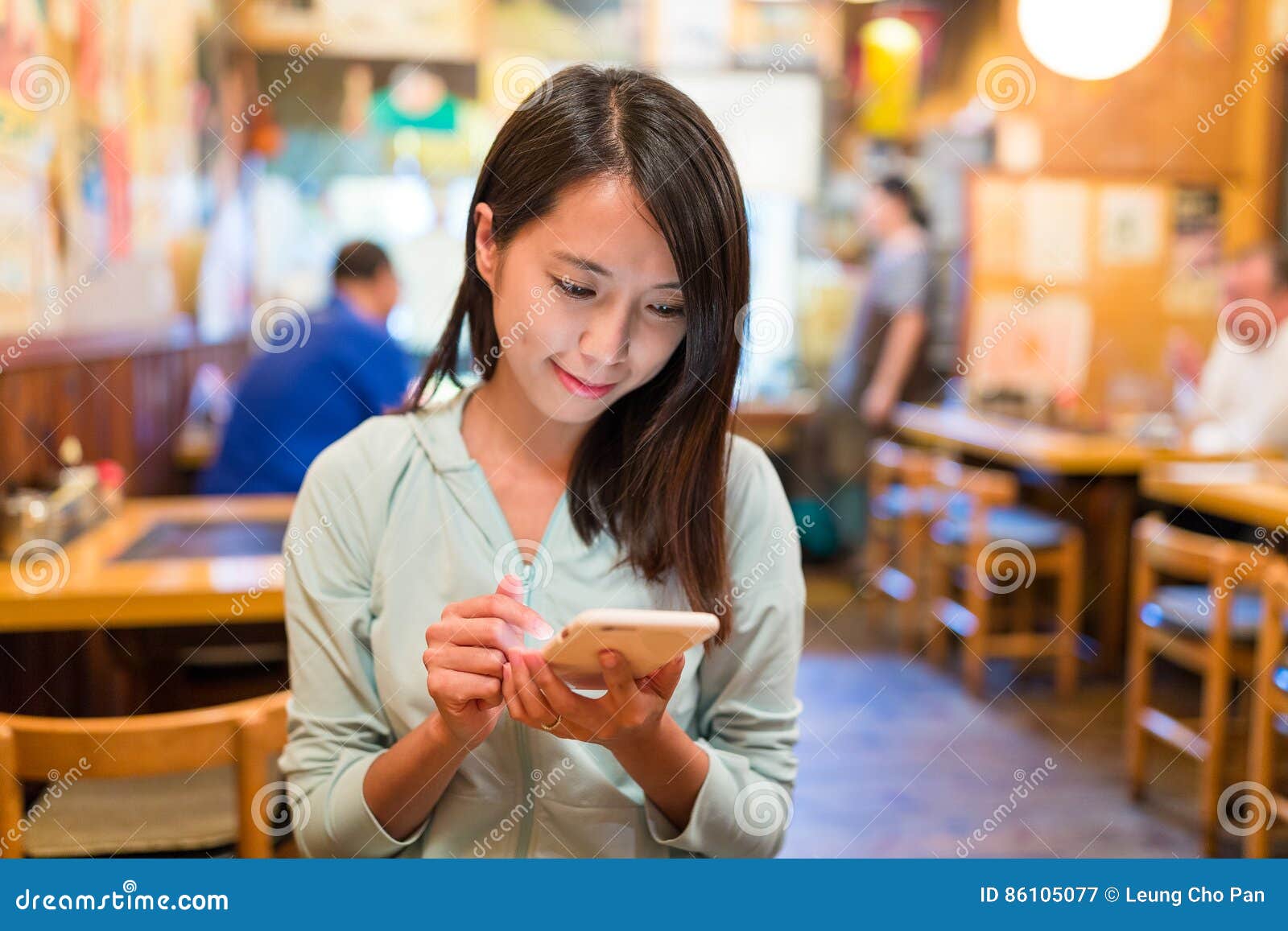 Woman Using Cellphone Inside Japanese Restaurant Stock Image - Image of ...