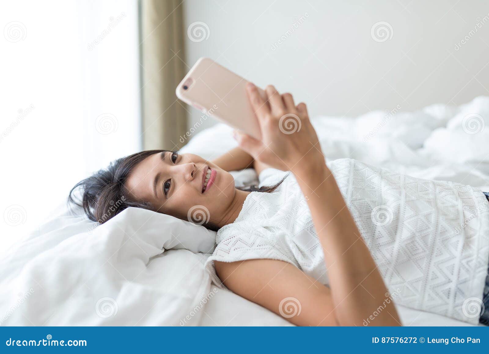 Woman Using Cellphone and Lay Down on Bed Stock Photo - Image of korean ...