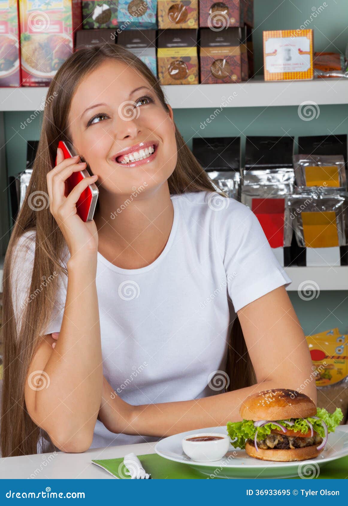 Woman Using Cellphone at Table in Supermarket Stock Image - Image of ...