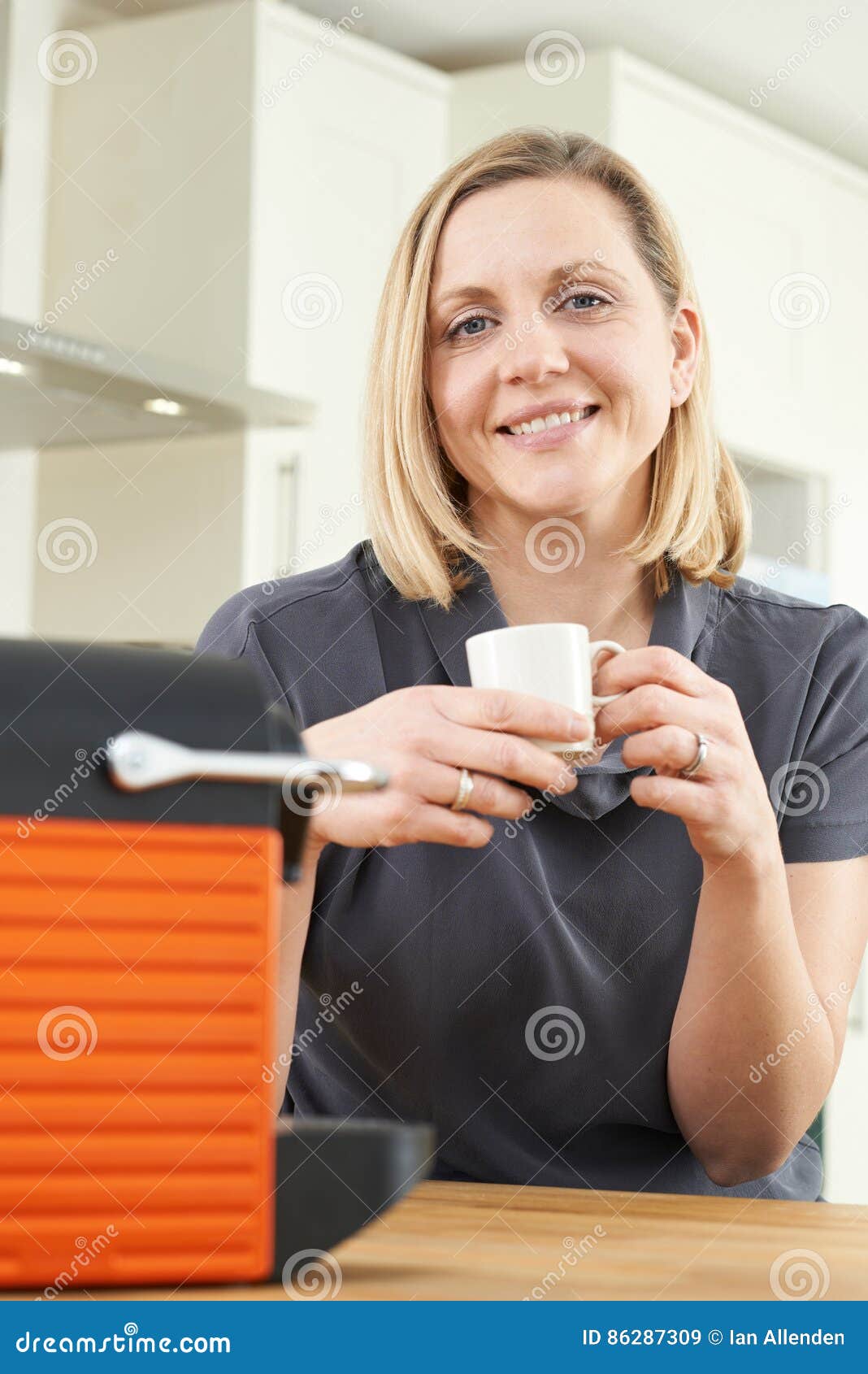 Woman Using Coffee Capsule Machine in Kitchen Stock Image - Image of ...