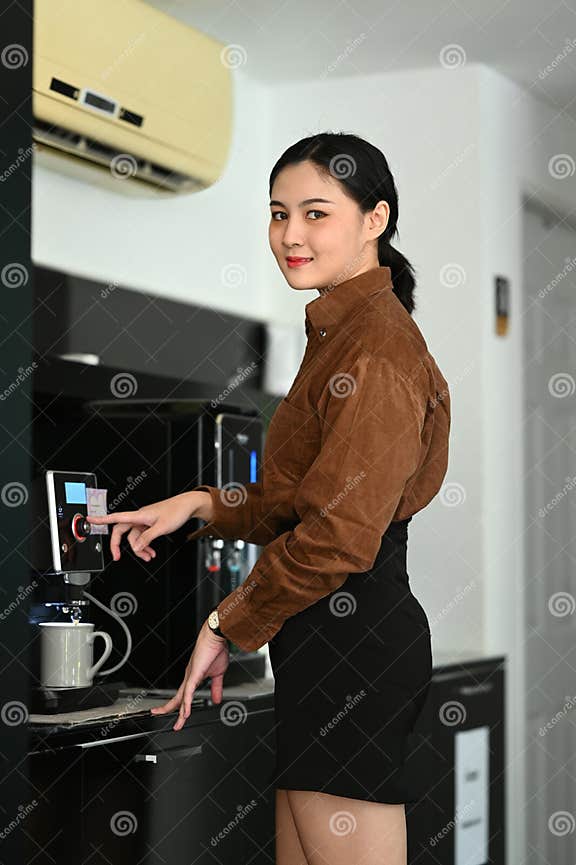 Woman Using Coffee Machine in Modern Office. Stock Image - Image of ...