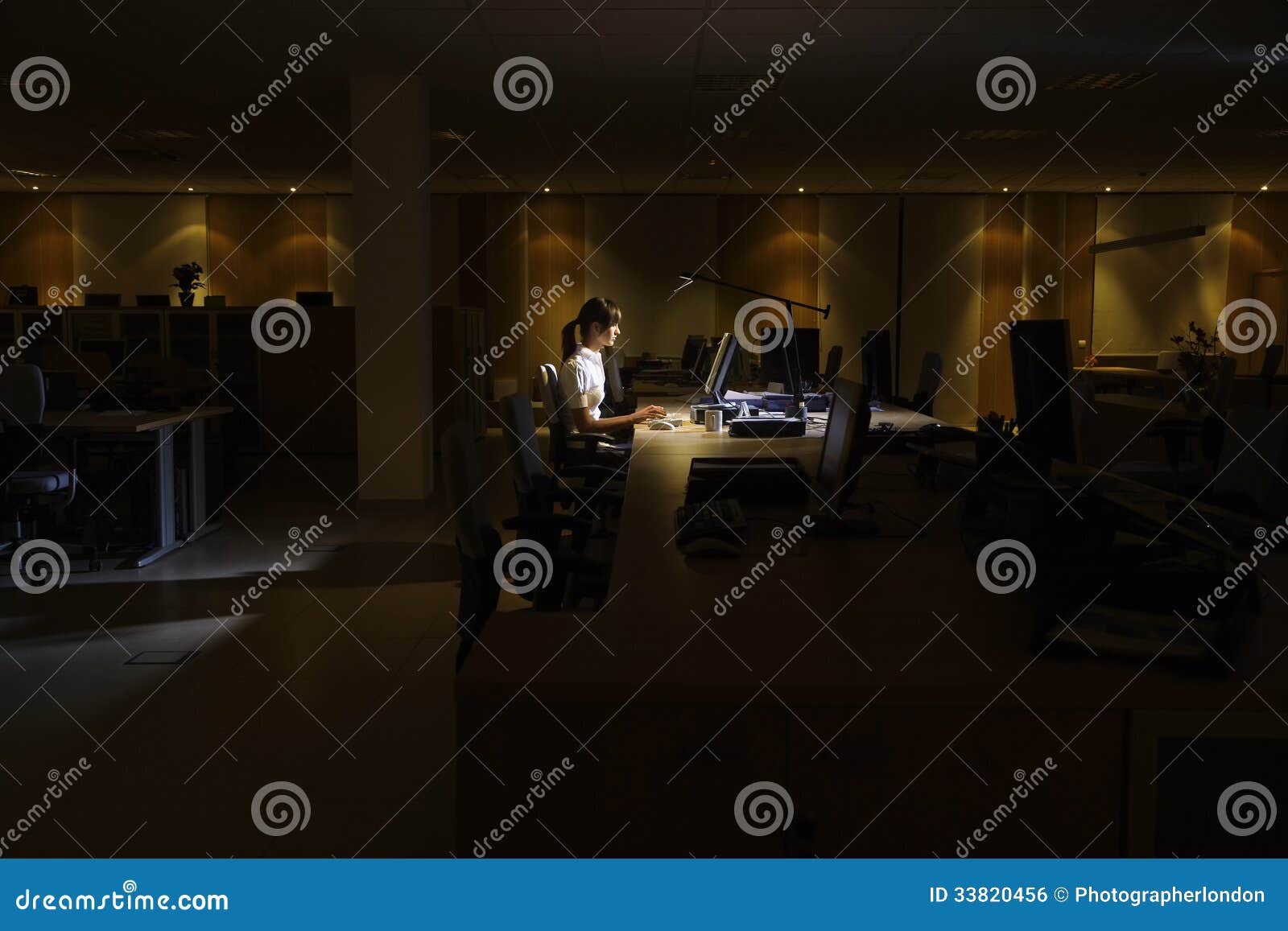 Woman Using Computer in Dark Office Stock Photo - Image of monitor ...