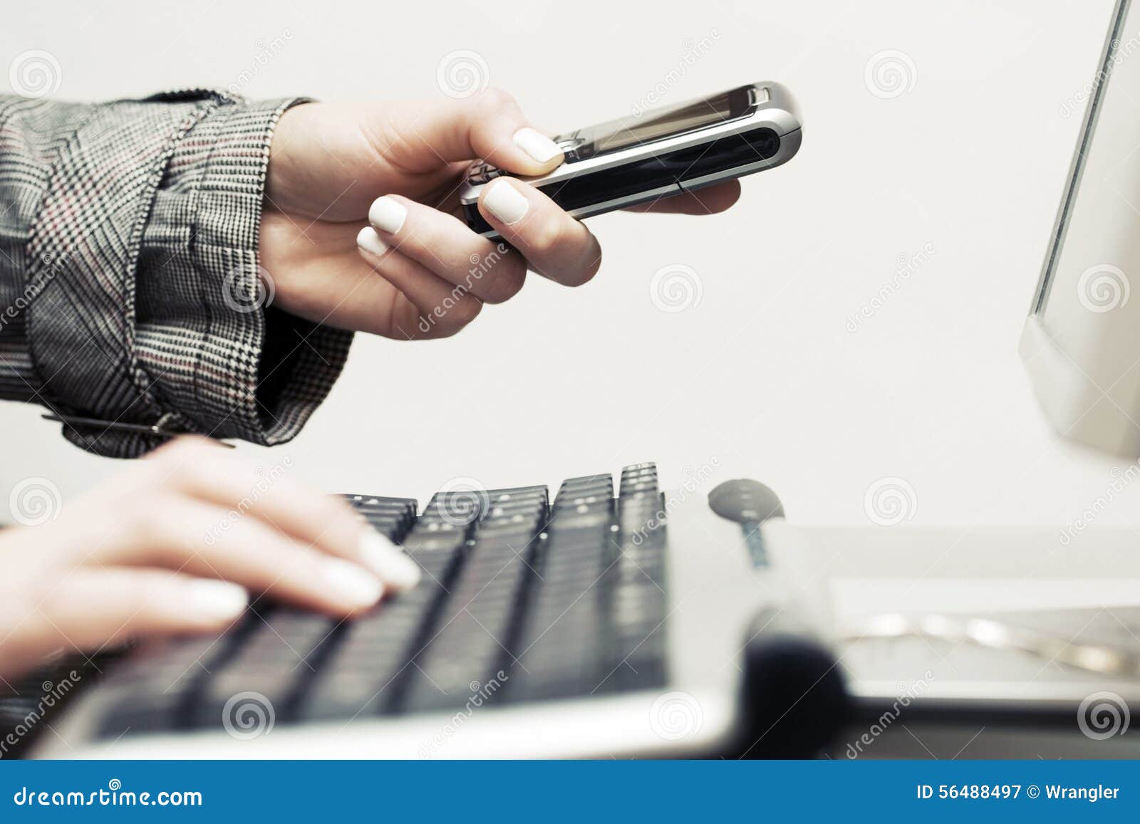 Woman Using Computer Keyboard and Calling on Cell Phone Stock Image ...