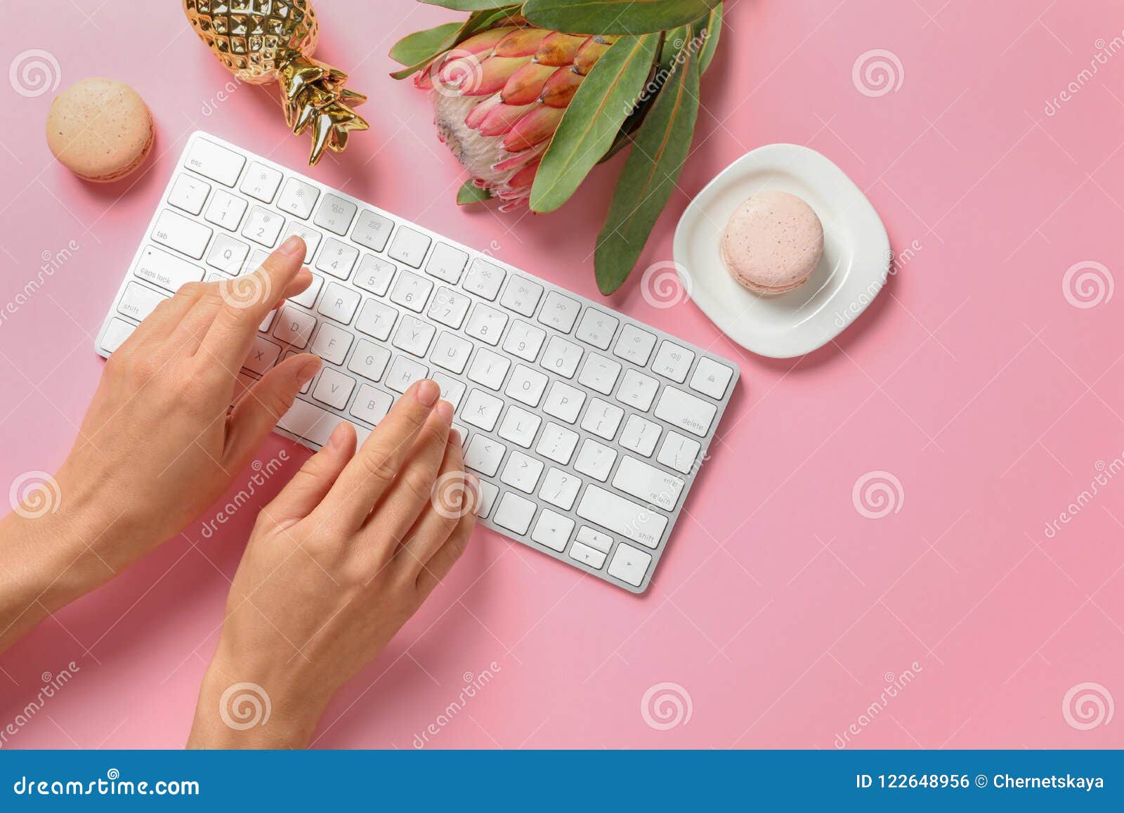 Woman Using Computer Keyboard on Table Decorated with Tropical Flower ...