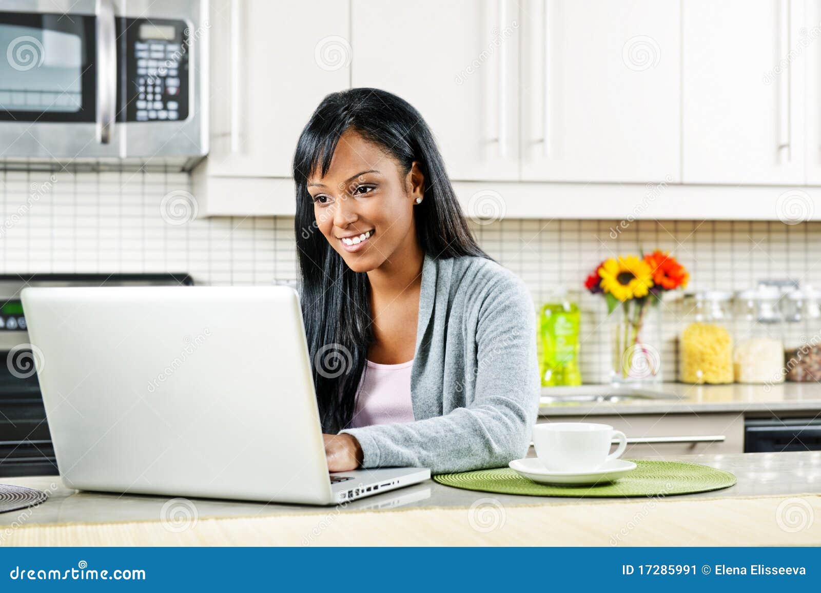 Woman Using Computer in Kitchen Stock Image - Image of confident ...
