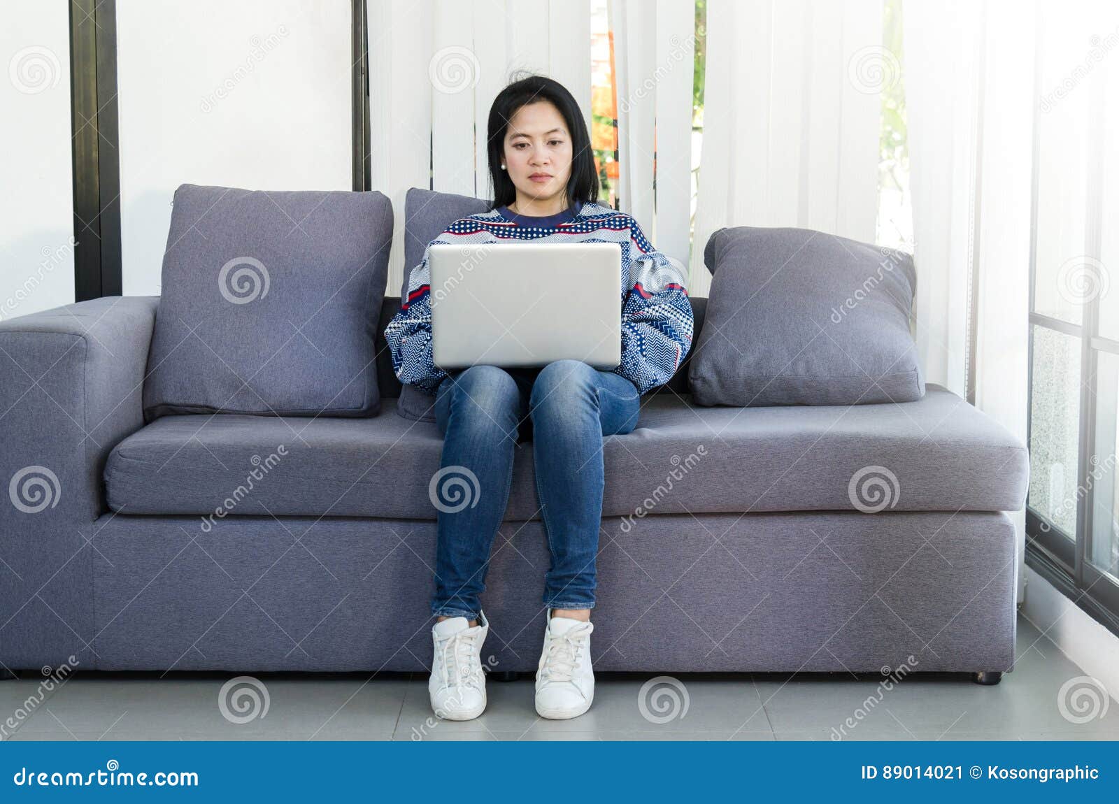 Woman Using Computer Laptop on Sofa in Her House. Stock Image - Image ...