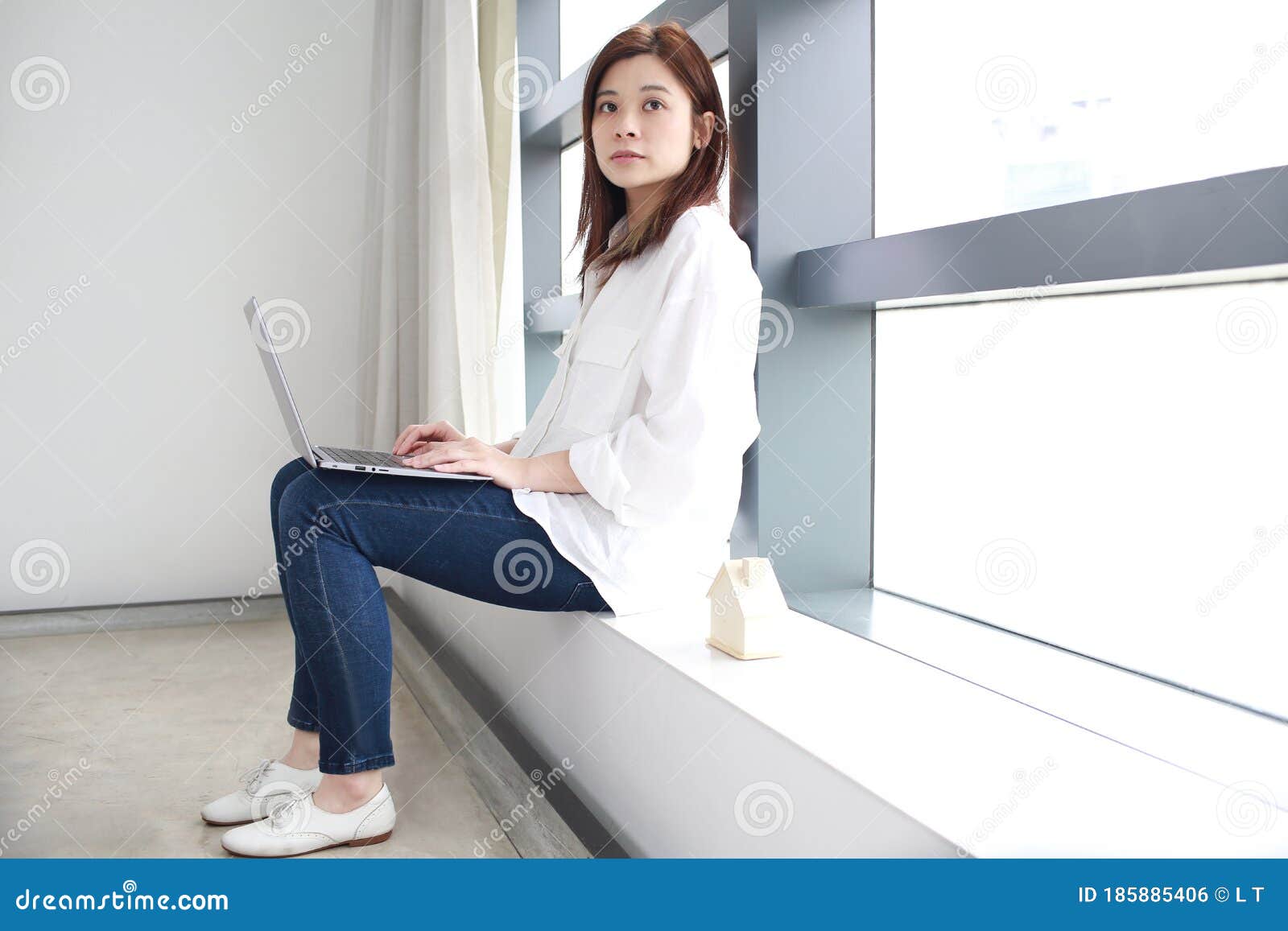 Woman Using the Computer Near the Window Stock Photo - Image of ...