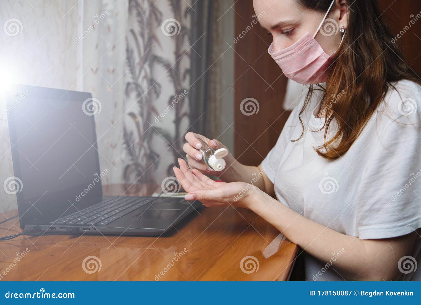 Woman Using Computer Wearing Mask and Applying Antiseptic.Precautions ...