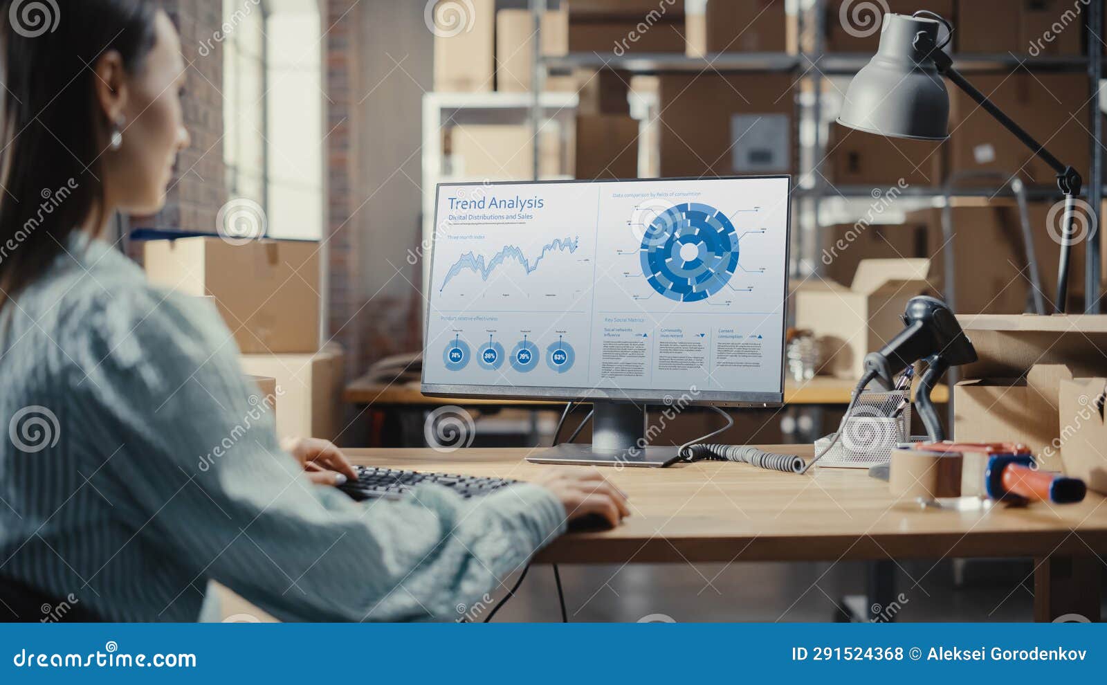 Woman Using Desktop Computer with a Trend Analysis Charts Display ...
