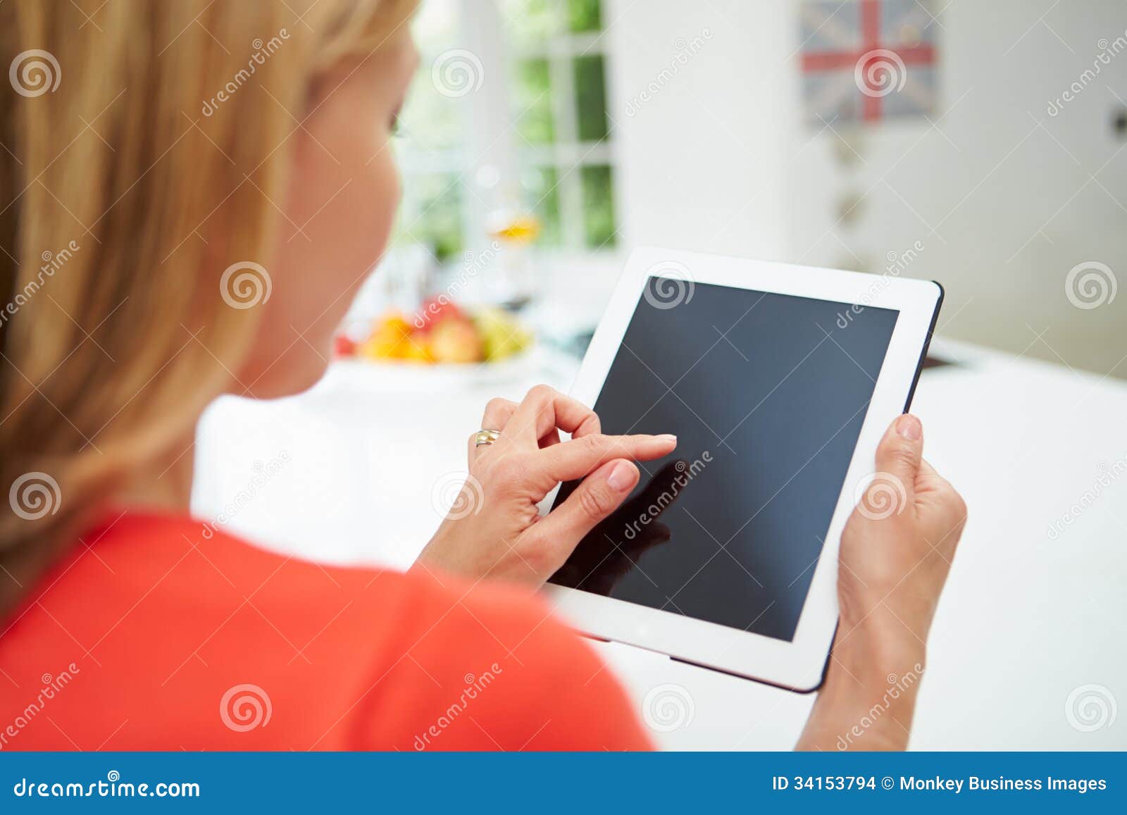 Woman Using Digital Tablet at Home in Kitchen Stock Photo - Image of ...