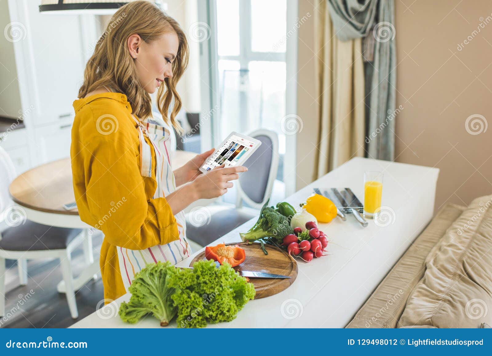 Woman Using Digital Tablet in Kitchen for Recipe Editorial Photography ... Woman Using Digital Tablet in Kitchen for Recipe Editorial Photography ...