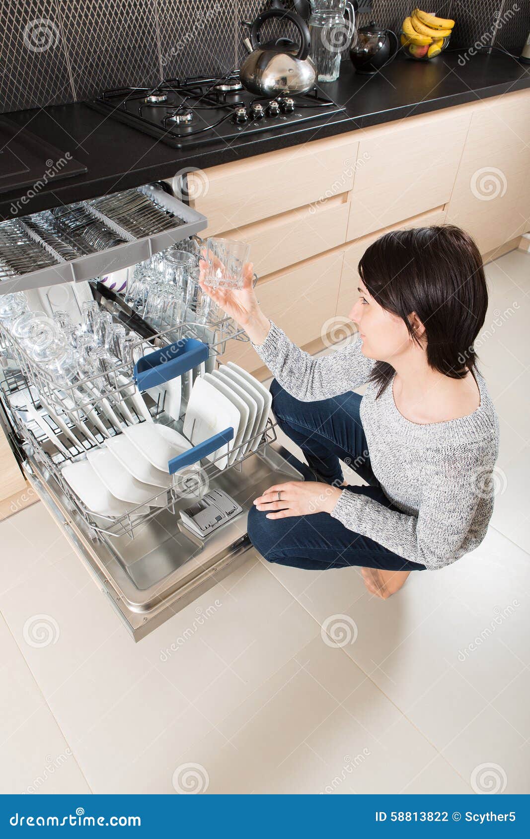 Woman Using a Dishwasher in a Modern Kitchen. Stock Photo - Image of ...