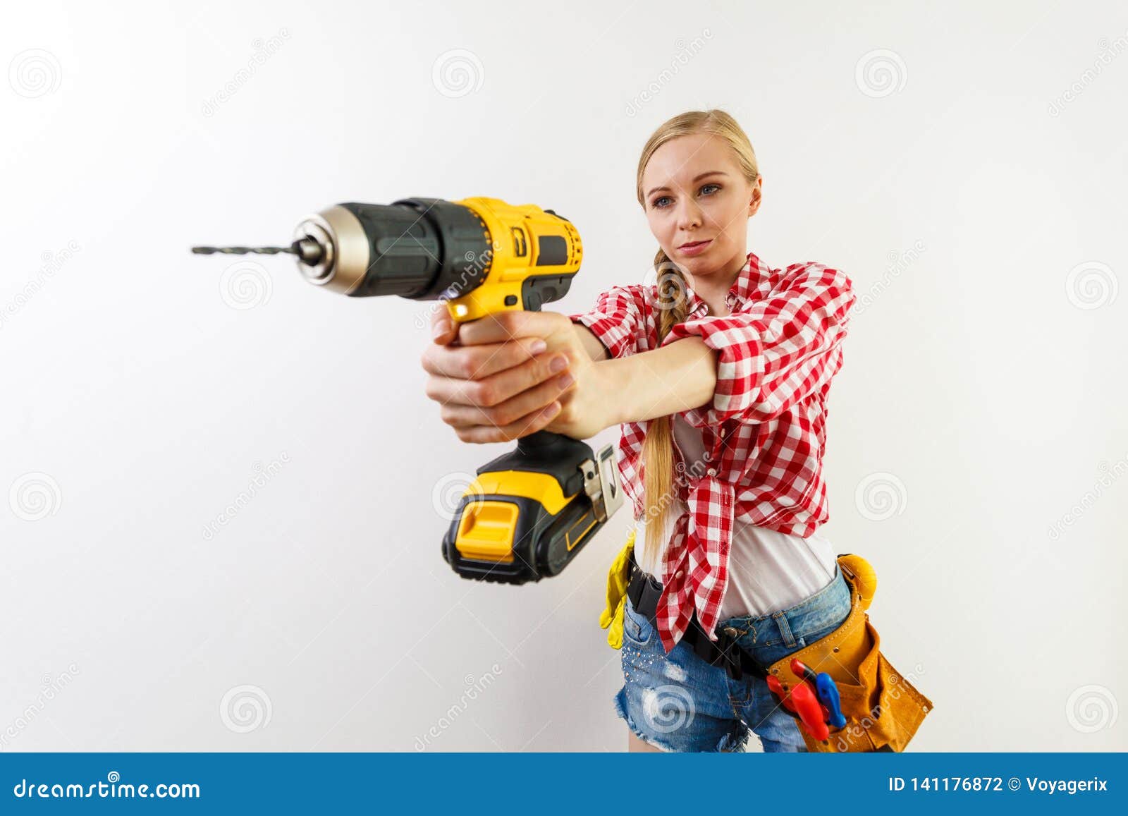 Woman using drill on wall stock photo. Image of aiming - 141176872