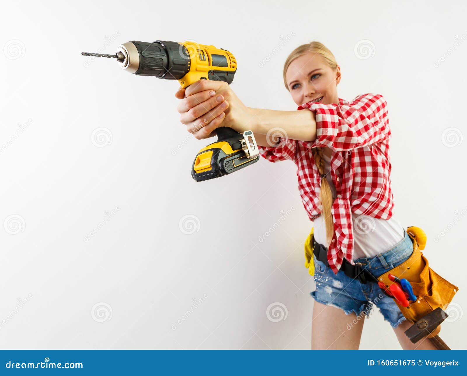 Woman using drill on wall stock image. Image of builder - 160651675