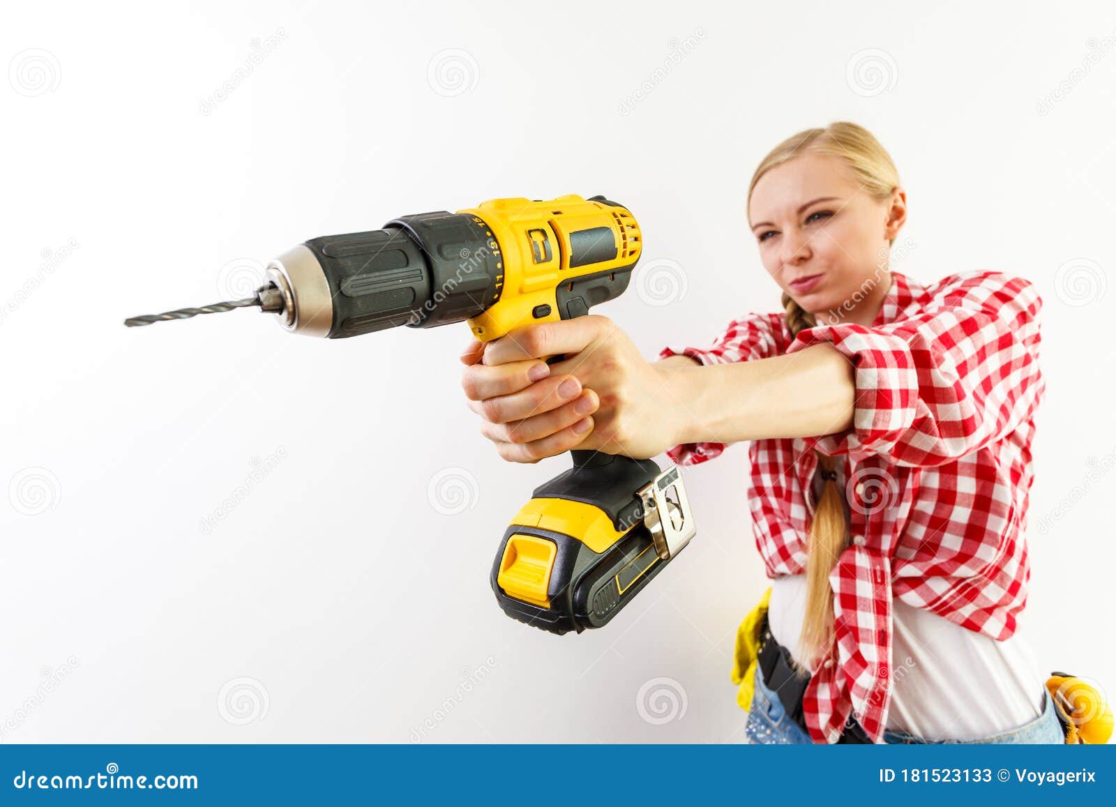 Woman using drill on wall stock image. Image of builder - 181523133