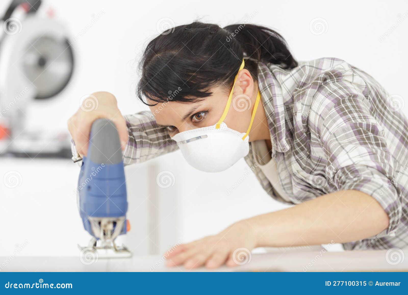 Woman Using Electric Jigsaw and Wearing Dust Mask Stock Image - Image ...