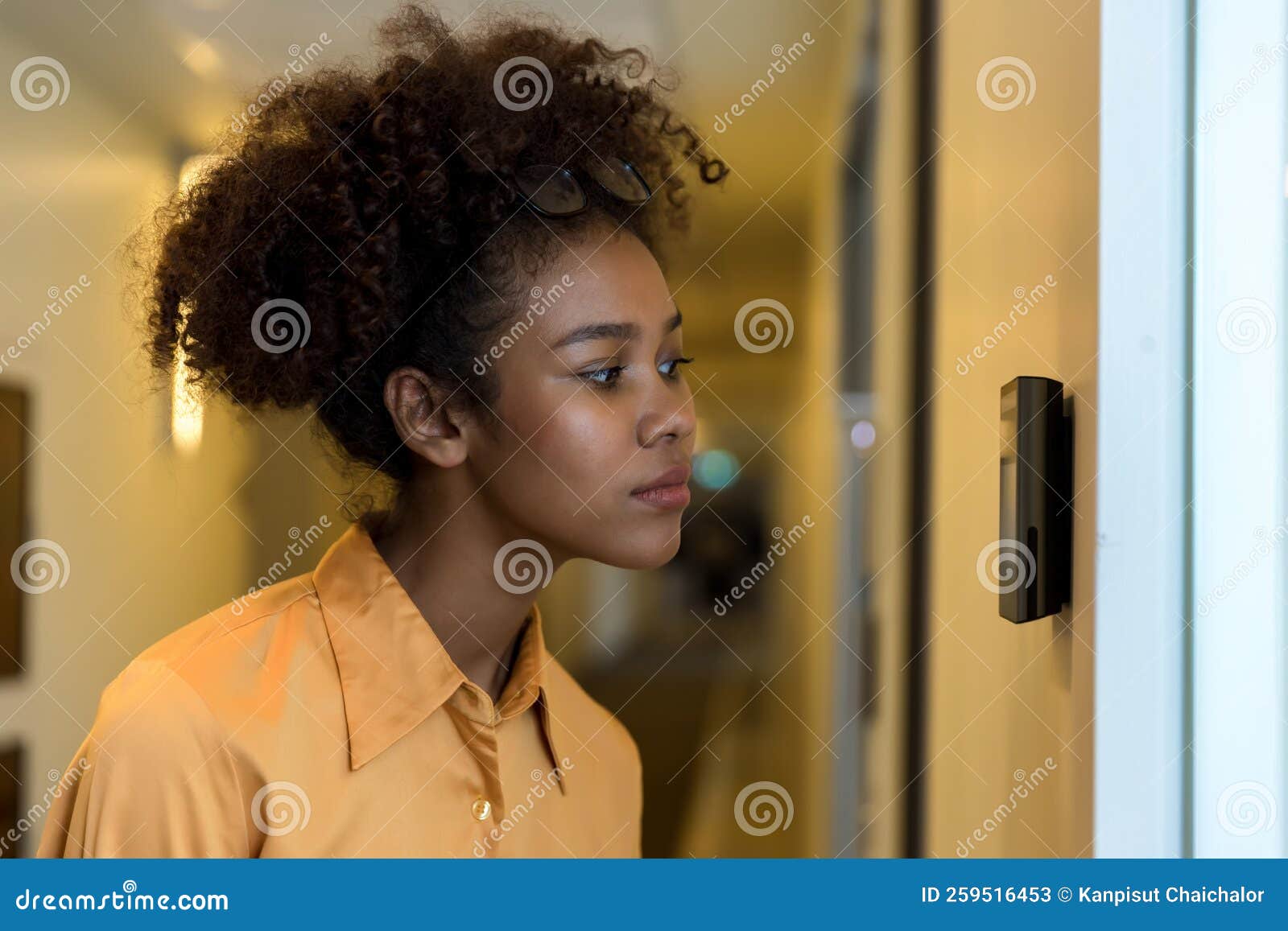 Woman Using Face Scanner To Unlock Door In Office Building Access