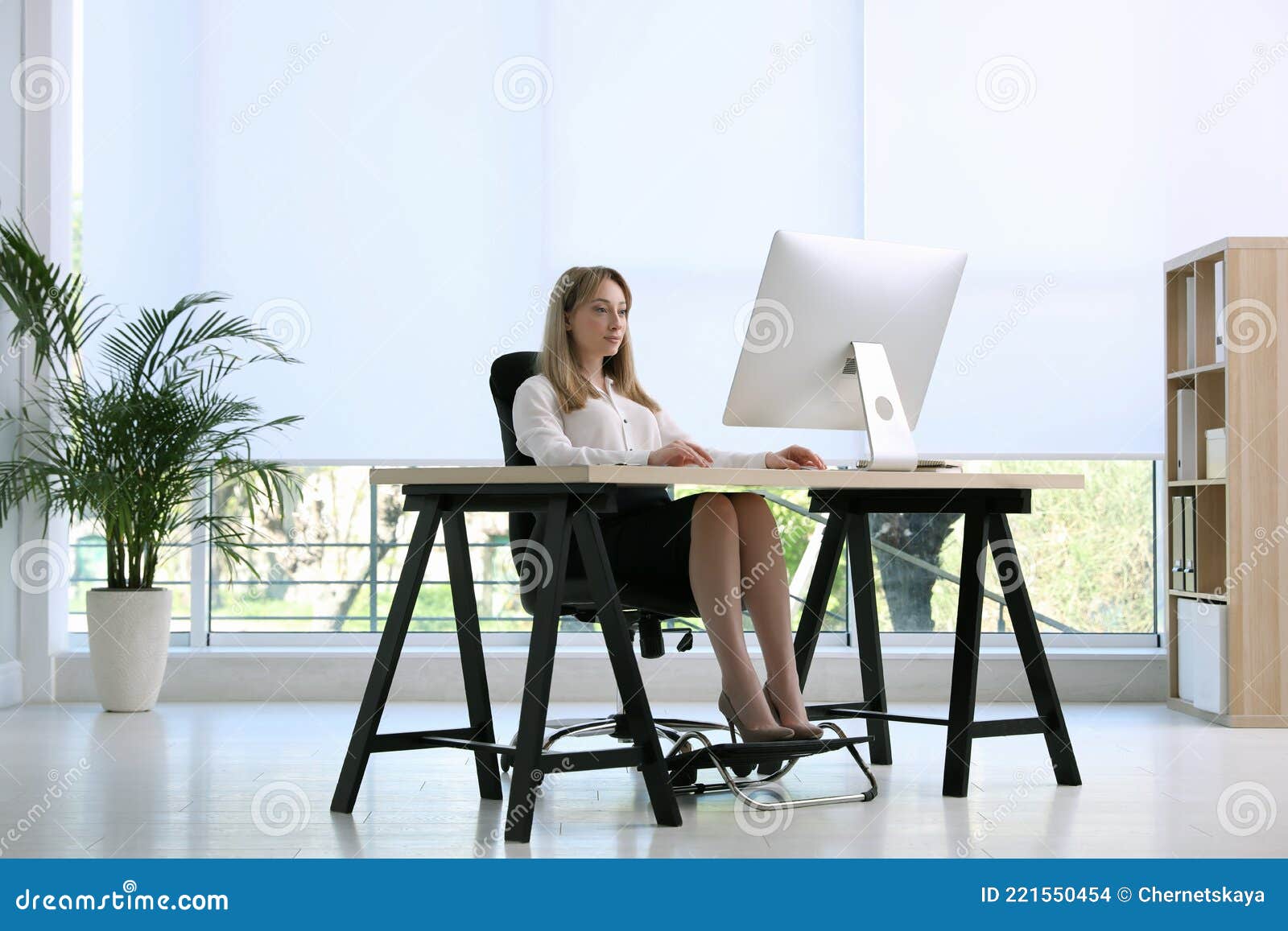 Woman Using Footrest while Working on Computer Stock Photo - Image of ...