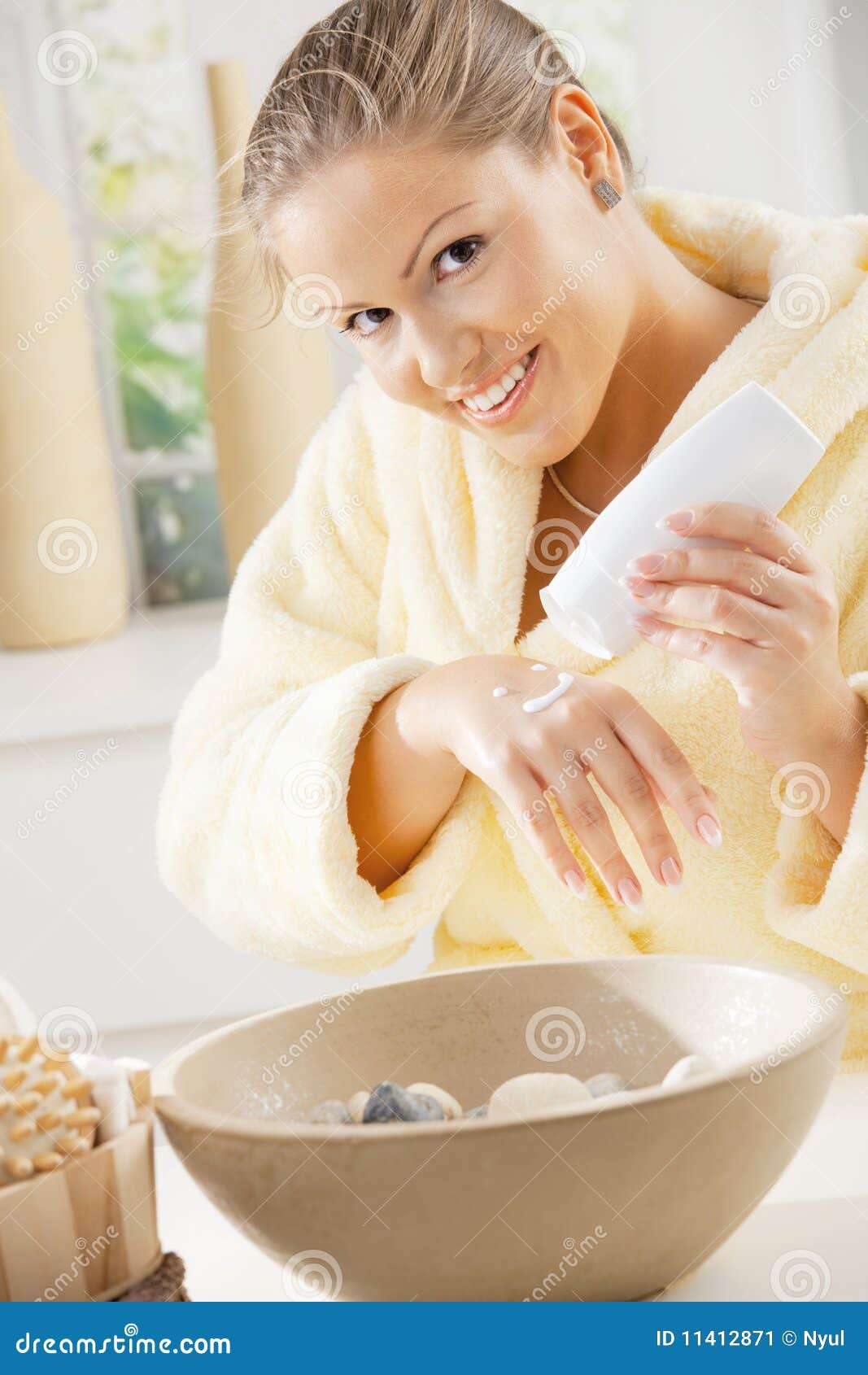 Woman using hand cream stock image. Image of expression - 11412871