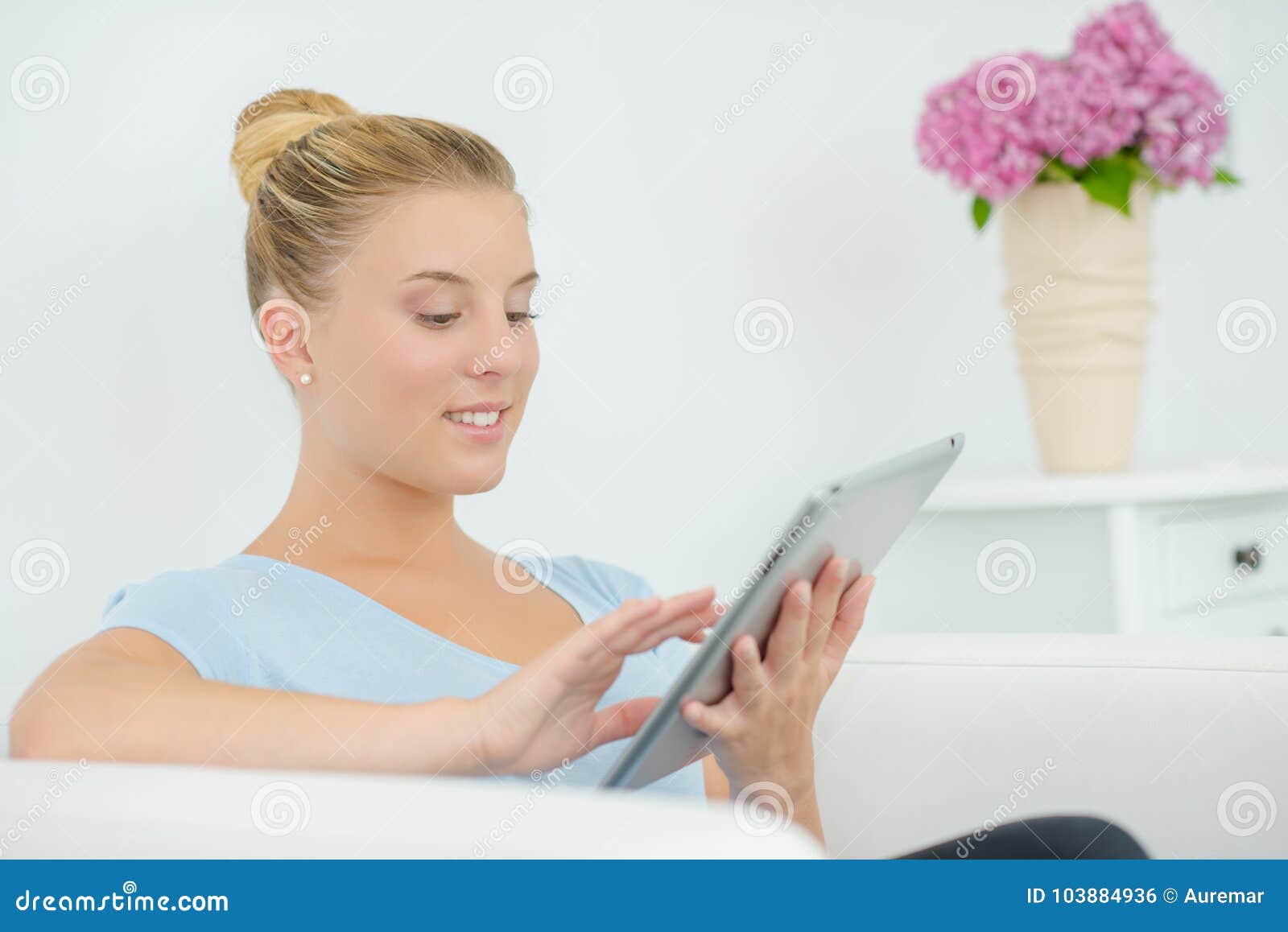 Woman Using Tablet Computer As she Waits for Appointment Stock Photo ...