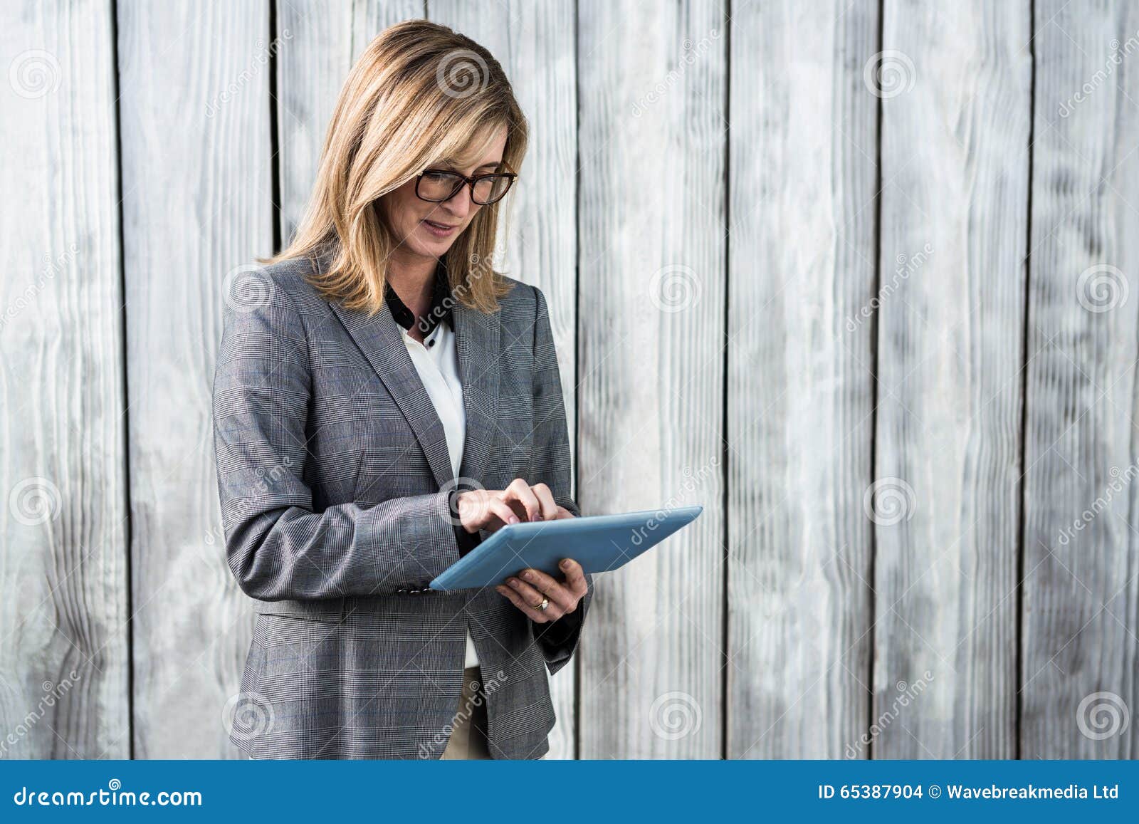 Woman using her tablet stock photo. Image of focused - 65387904