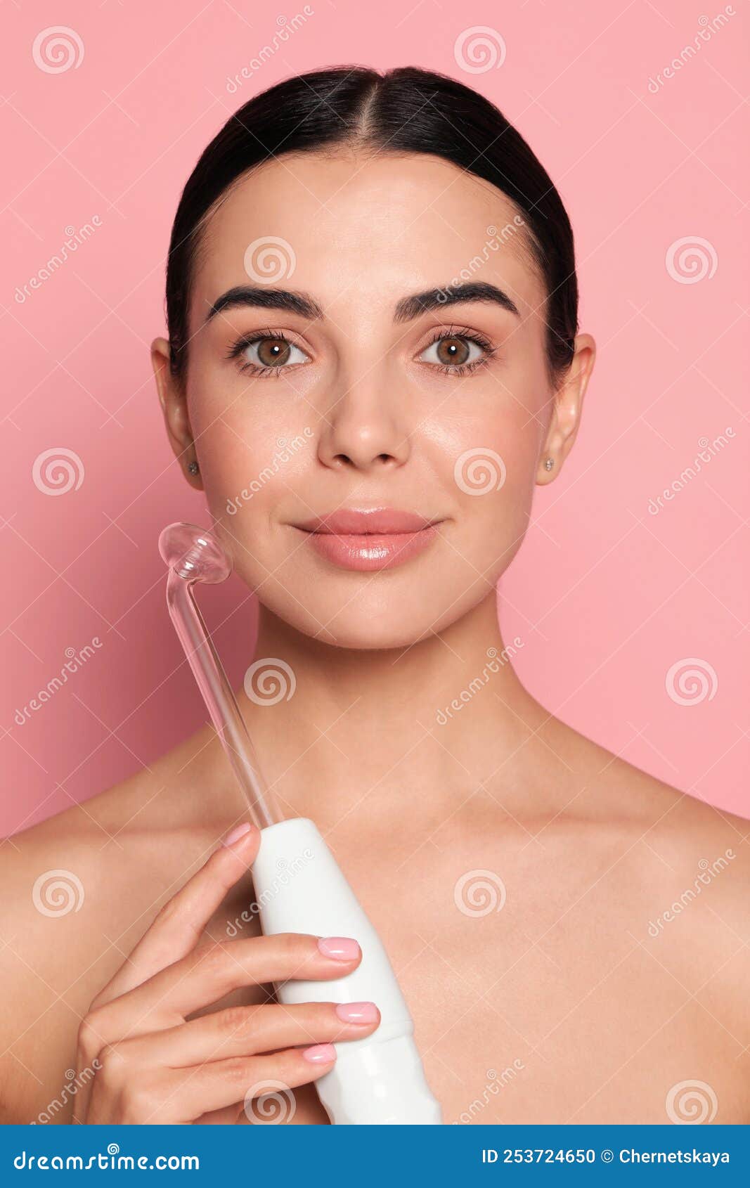 Woman Using High Frequency Darsonval Device on Pink Background Stock ...
