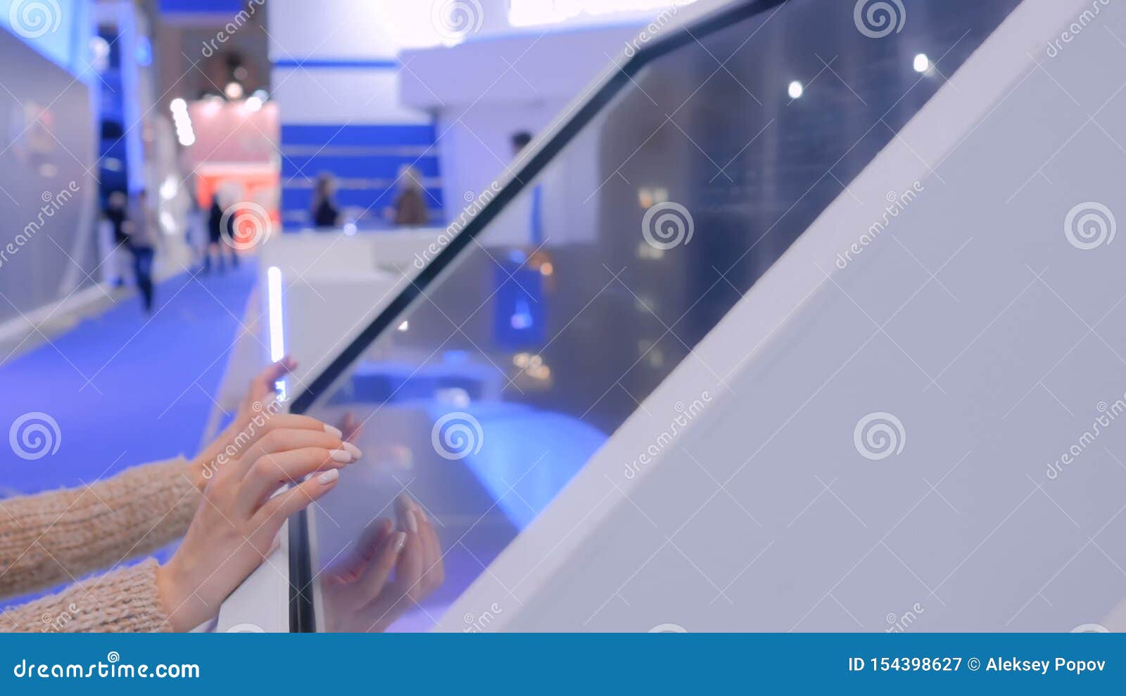 Woman Using Interactive Touchscreen Display at Technology Exhibition ...