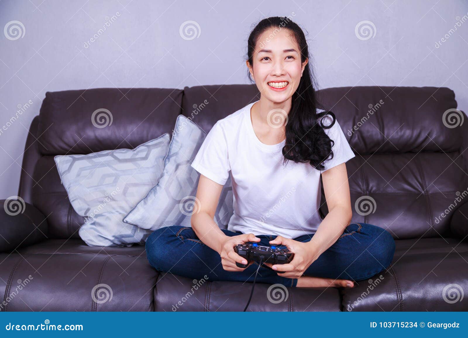 Woman Using Joystick Controller Playing Video Game on Sofa in Li Stock ...