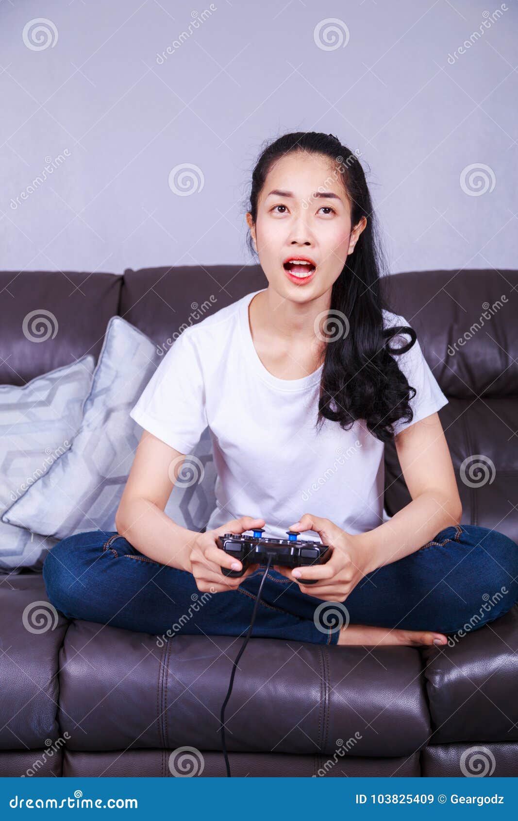 Woman Using Joystick Controller Playing Video Game on Sofa in Li Stock ...