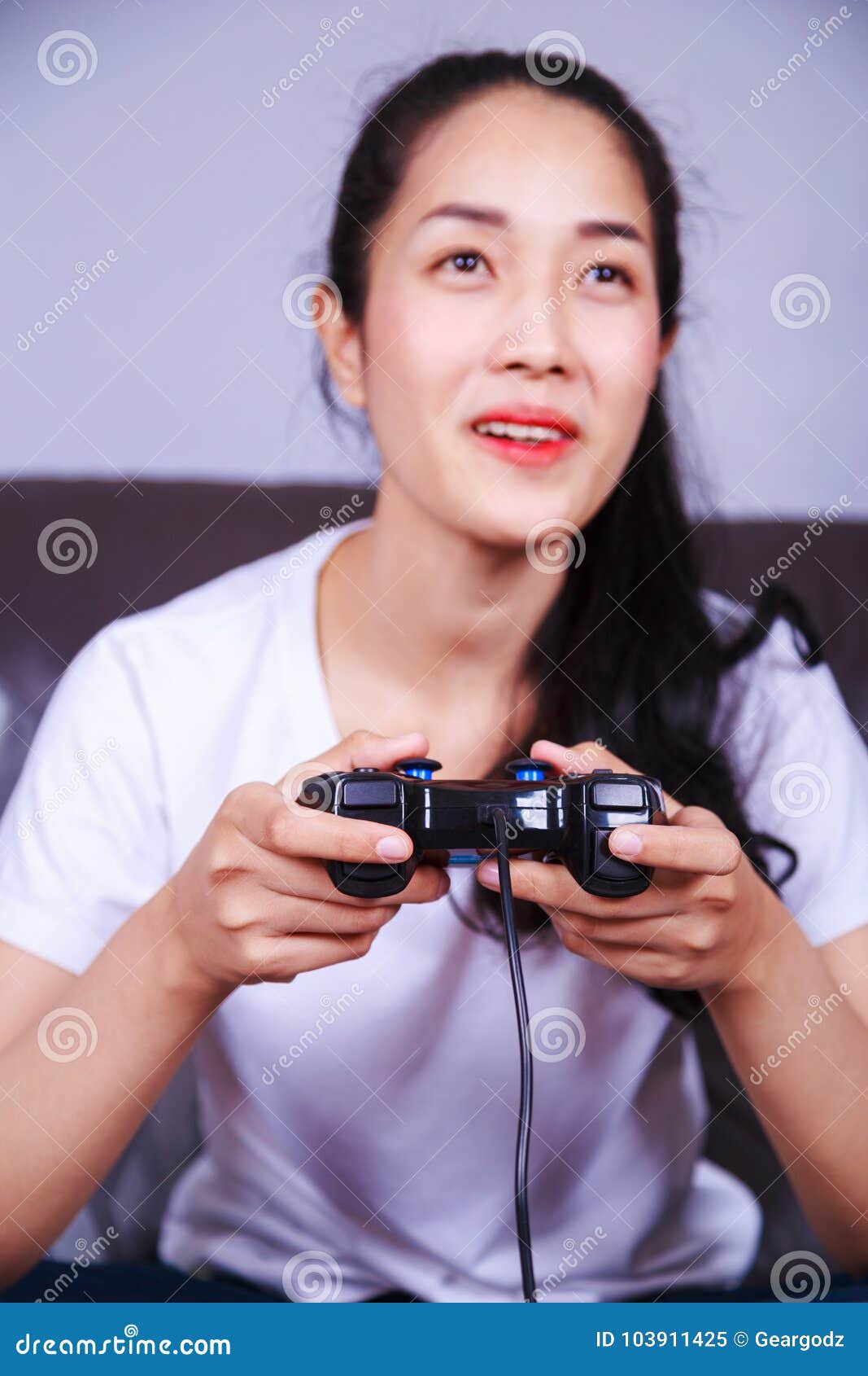 Woman Using Joystick Controller Playing Video Game on Sofa in Li Stock ...