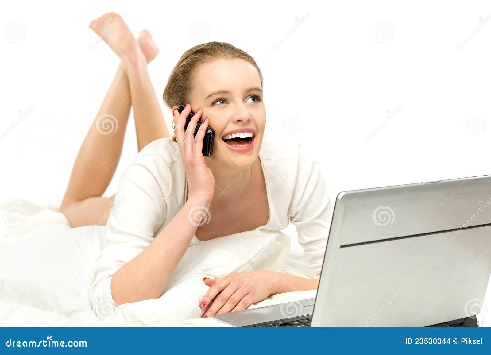 Woman using laptop in bed stock photo. Image of relaxation - 23530344