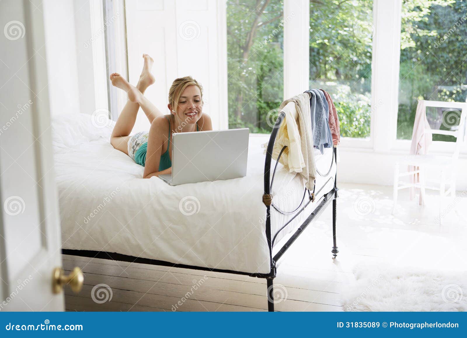 Woman Using Laptop in Bed stock image. Image of concept - 31835089
