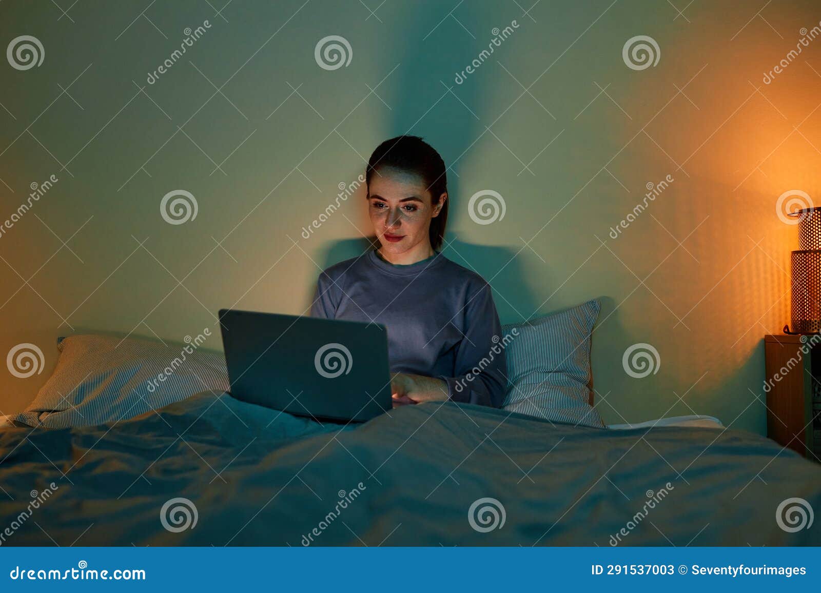 Woman Using Laptop in Bed at Night Lit by Screen Stock Image - Image of ...